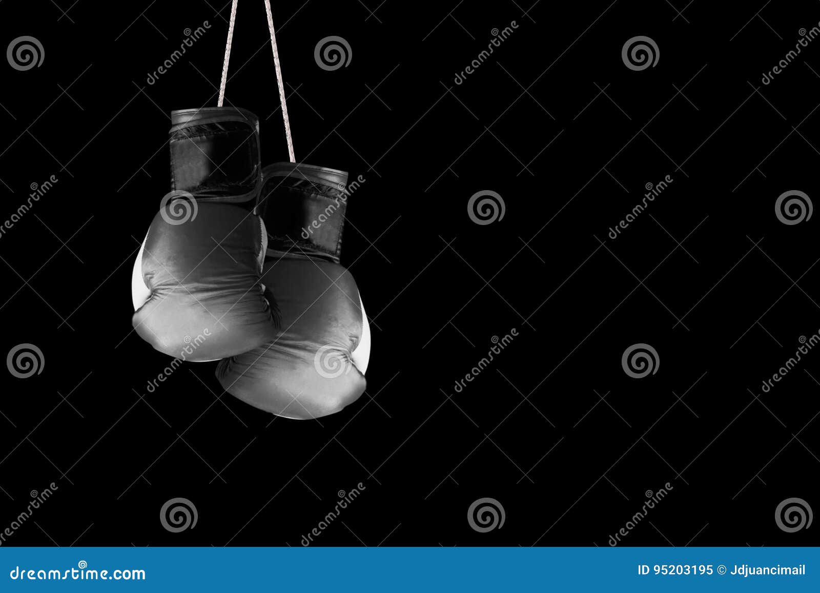 Pair of Boxing Gloves Hanging Against a Black Wall Background. Empty ...