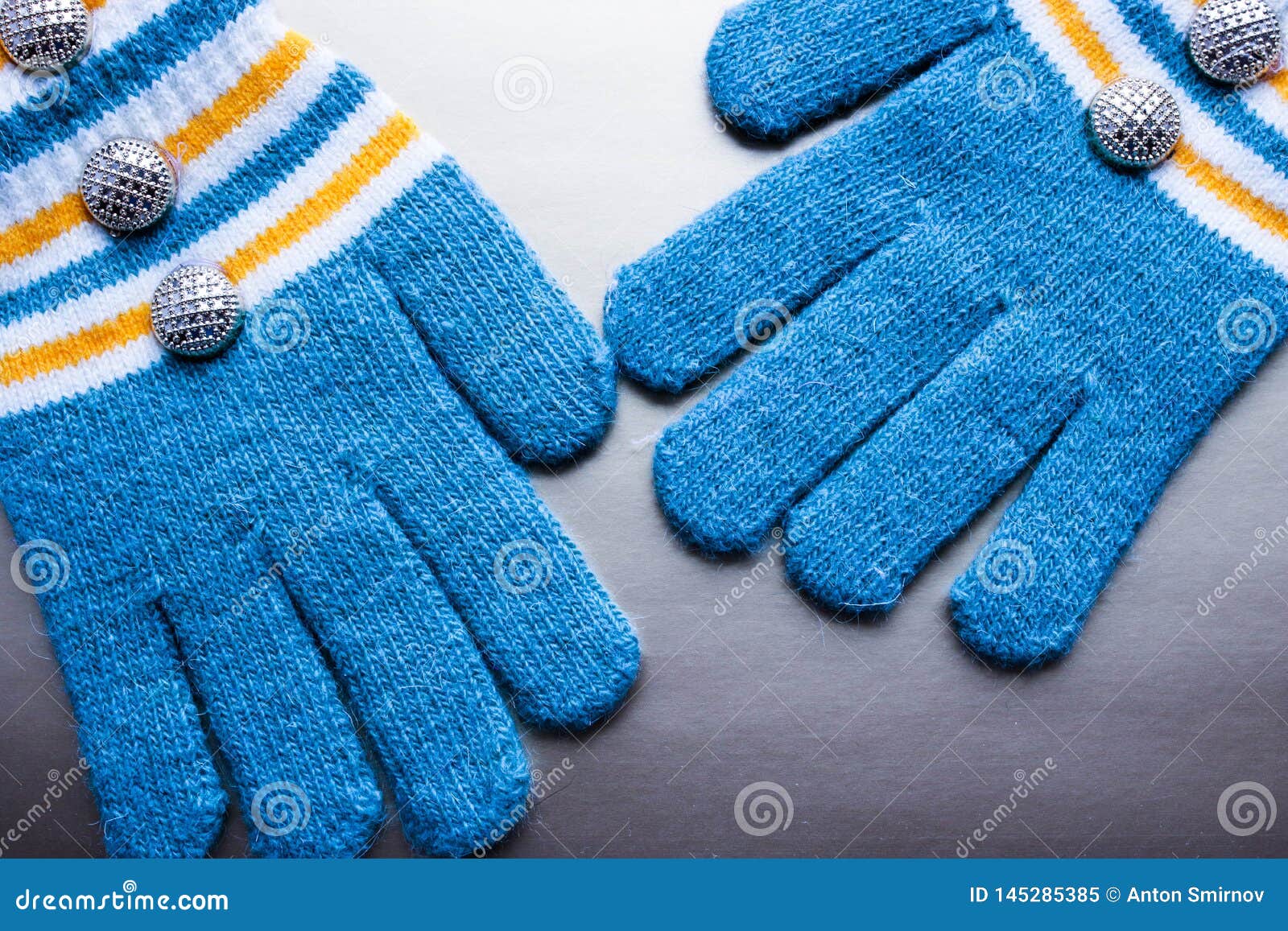 Blue Knitted Mittens on a Purple Background. Stock Image - Image of ...