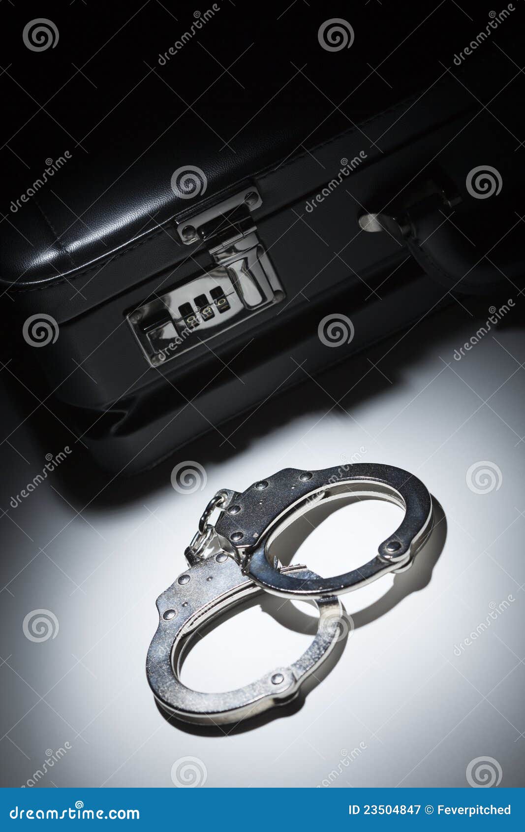 Pair of Handcuffs and Briefcase Under Spot Light Stock Image - Image of ...