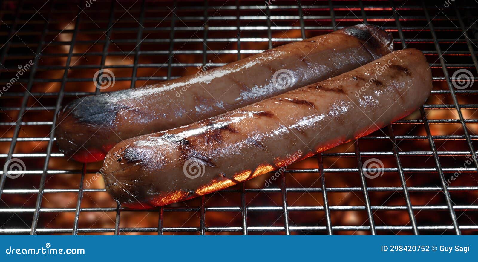 Pair of Hot Dogs Sizzling Over a Hot Grill Stock Photo - Image of ...
