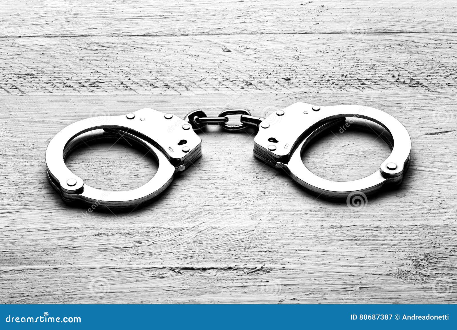 Pair of locked handcuffs stock image. Image of board - 80687387