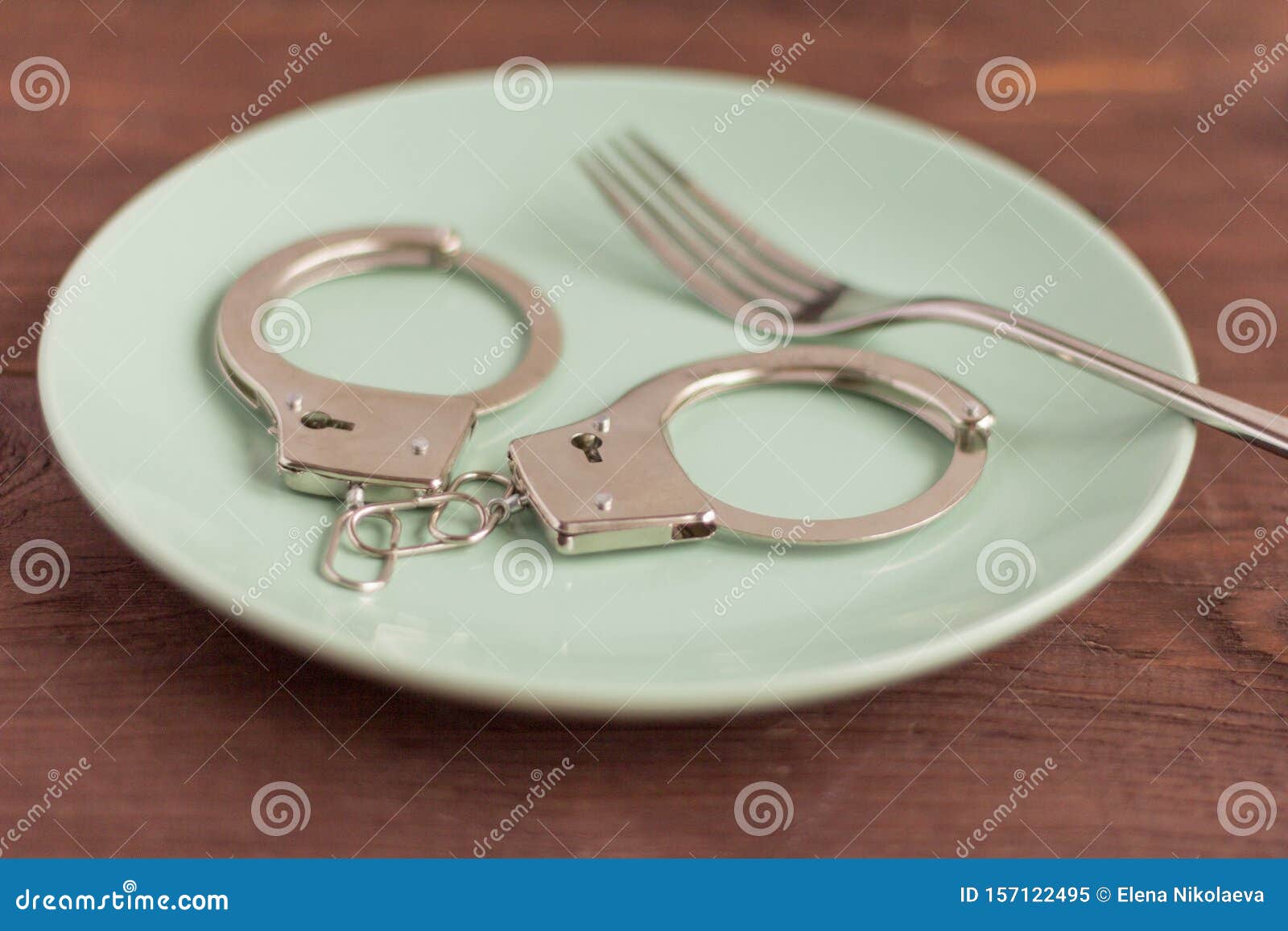 A Pair of Metal Handcuffs on a Plate Stock Image - Image of handcuffs ...