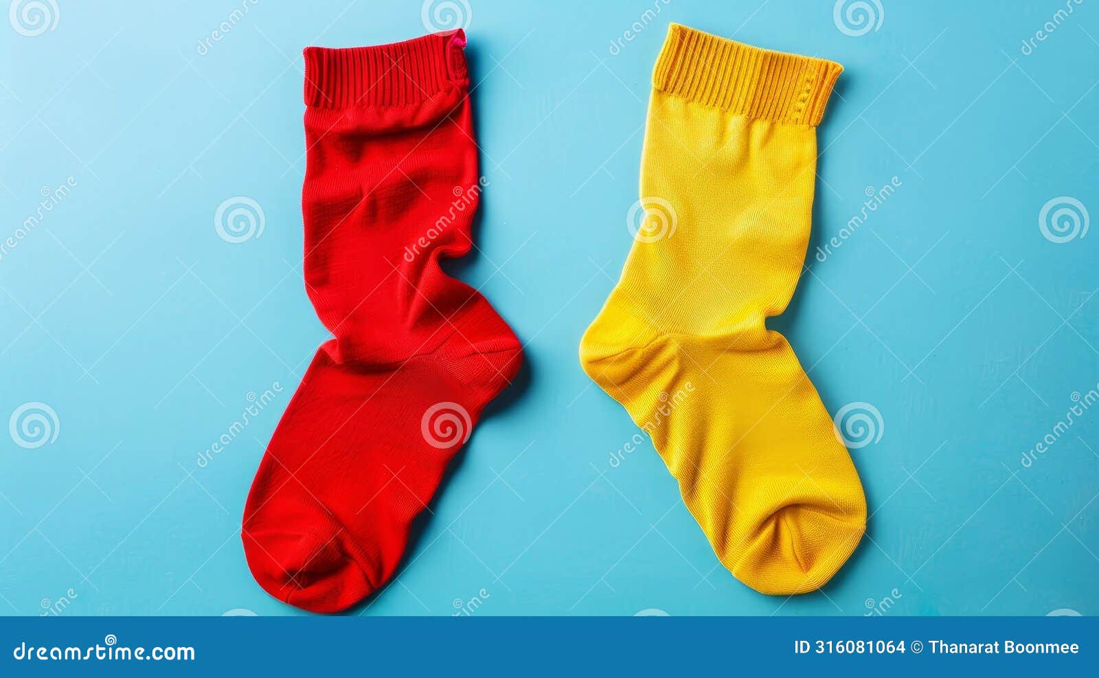 A Pair of Mismatched Socks Against a Light Blue Background ...