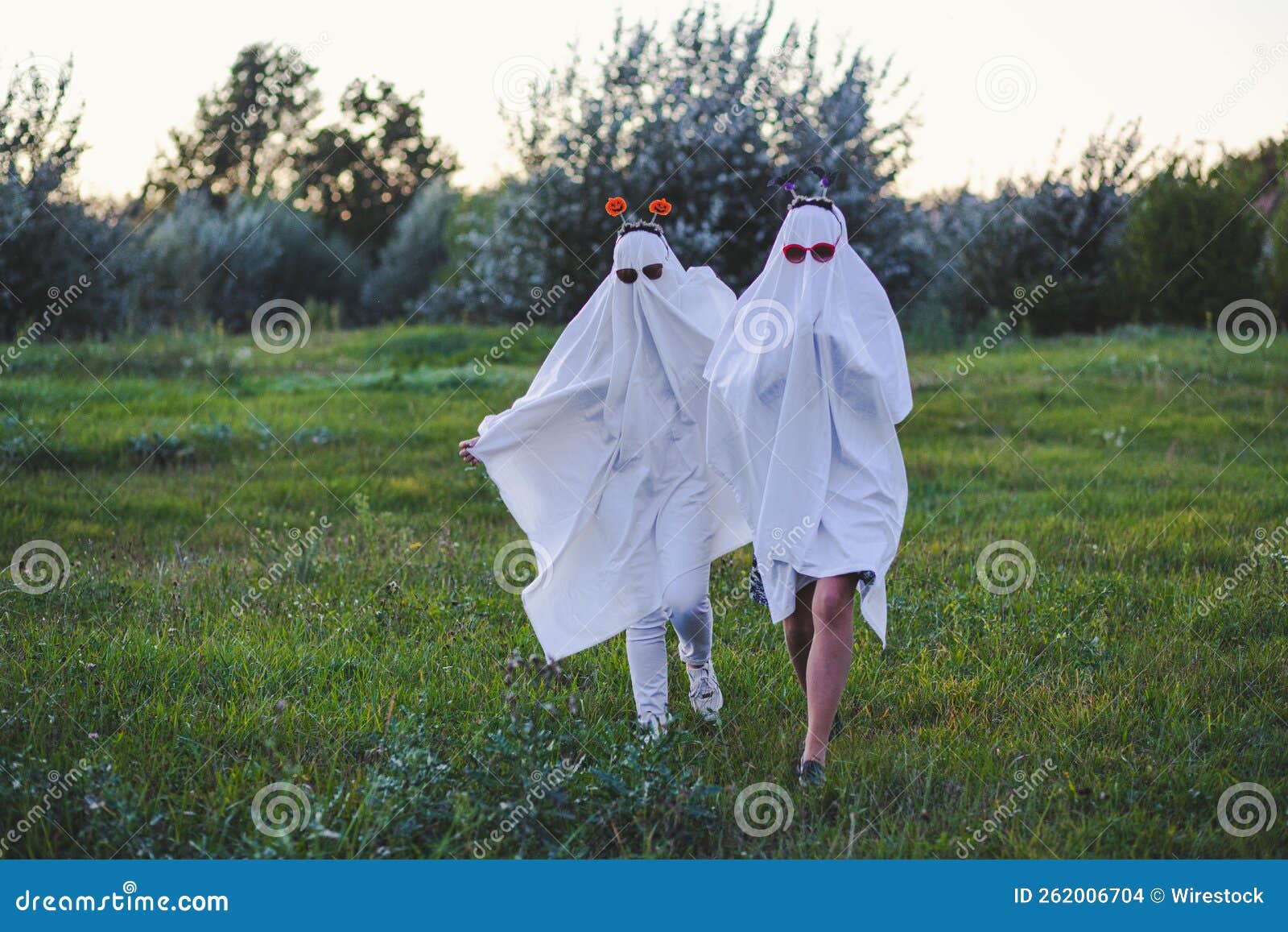 Pair of People in Ghost Costumes Running on a Field Stock Photo - Image ...