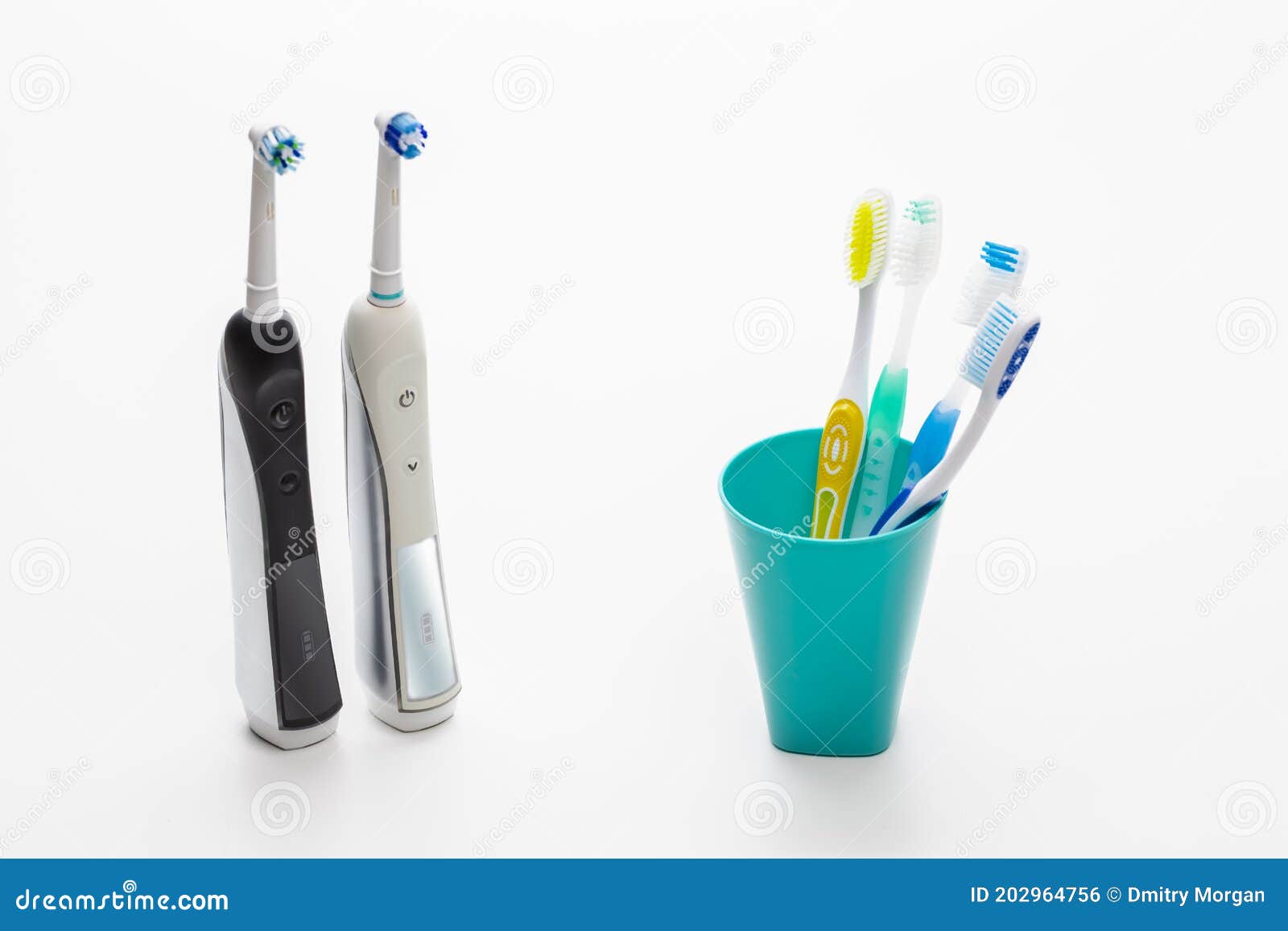 Pair of Professional Electric Toothbrushes in Front of Four Manual ...