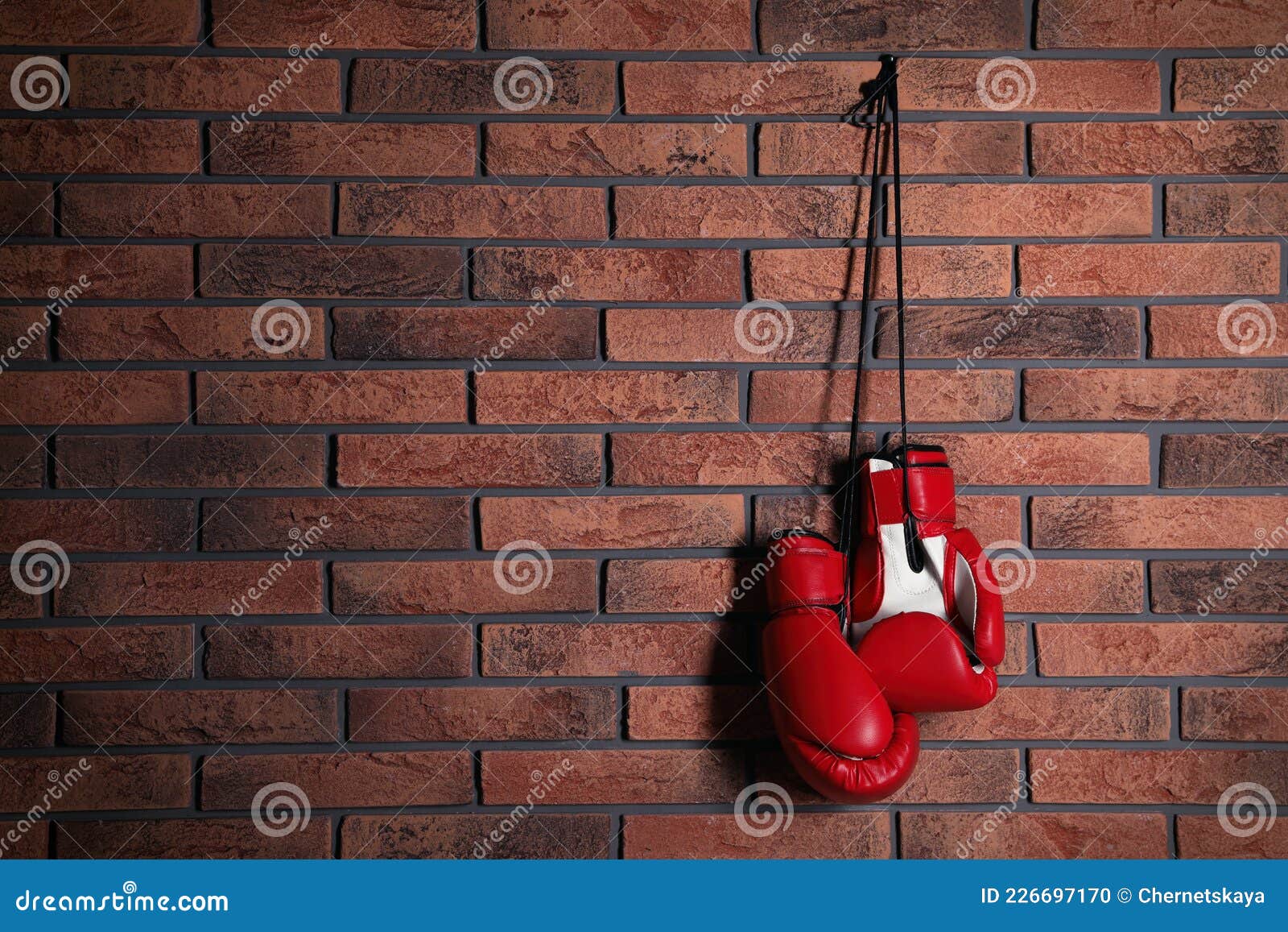 Pair of Red Boxing Gloves Hanging on Brick Wall, Space for Text Stock ...
