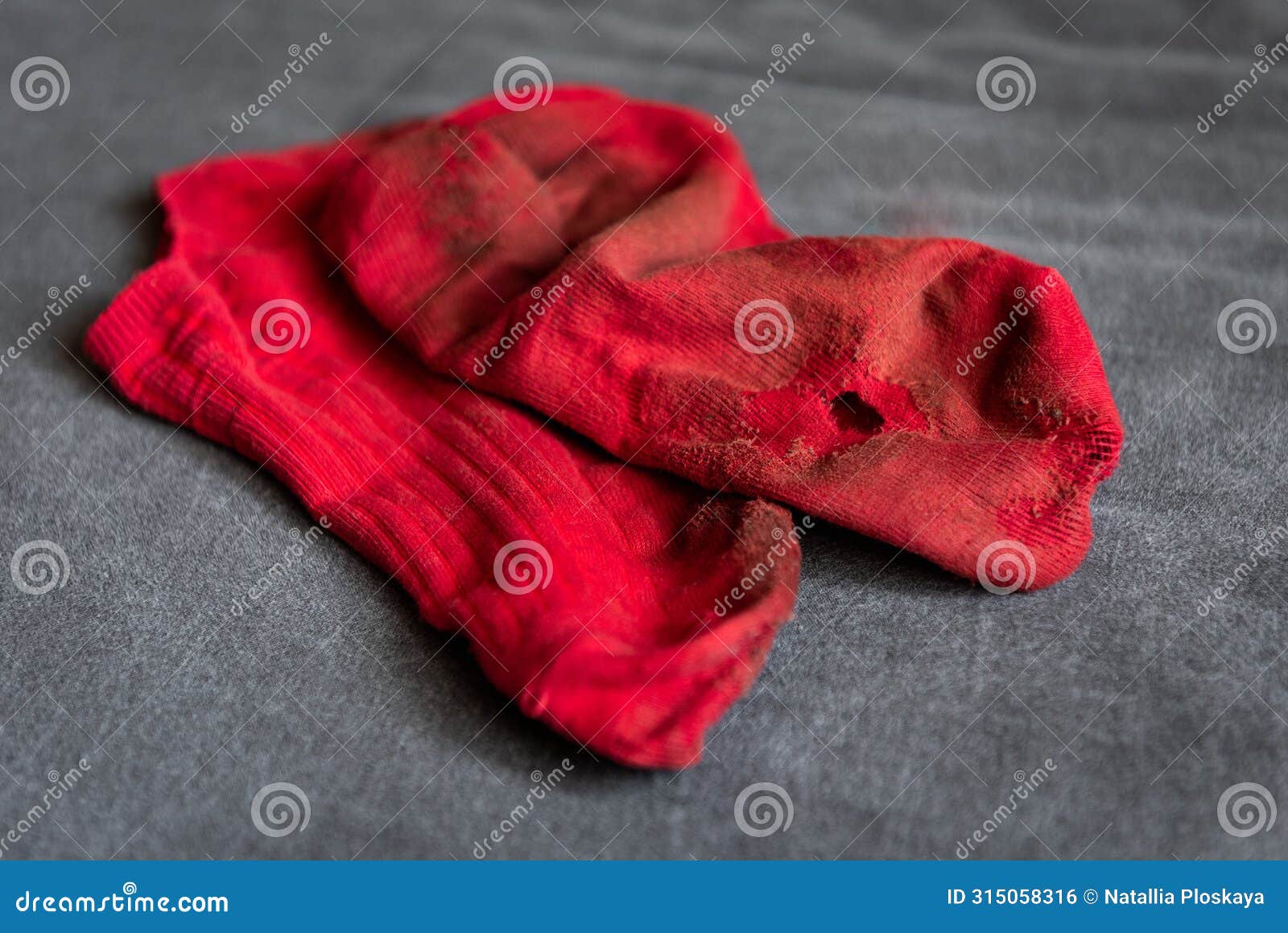 Pair of Red Dirty and Torn Socks Lying on Bed. Stock Photo - Image of ...