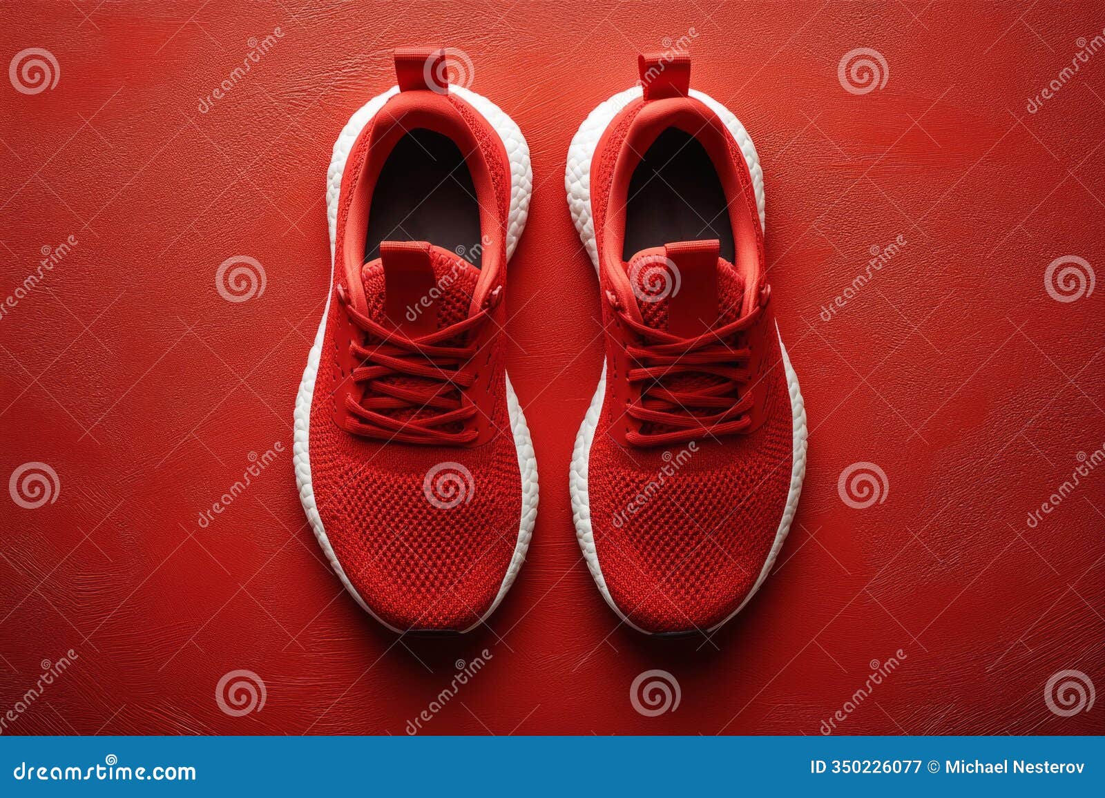 Pair of Red Sneakers Resting on Matching Red Surface Stock Image ...