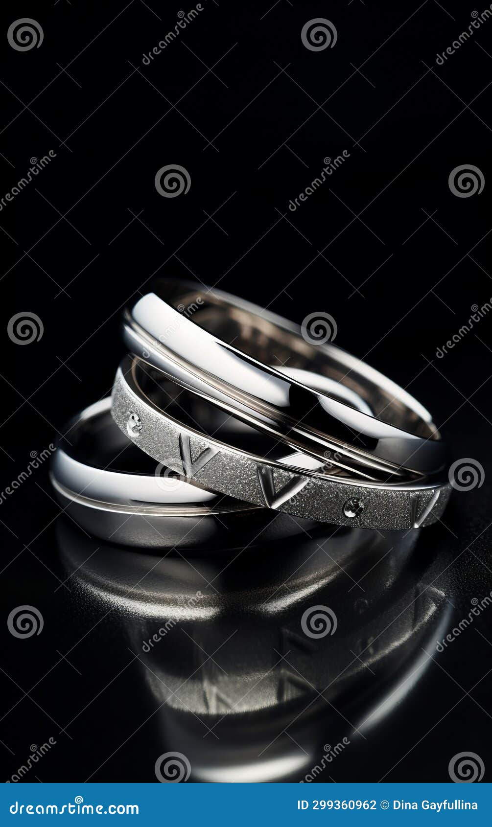 Pair of Silver Wedding Bands on a Reflective Dark Surface Stock Photo ...