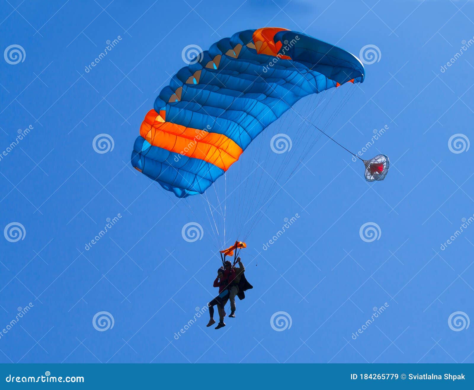 Pair of Skydivers on a Blue Sky Background. Tandem Parachuting Stock ...