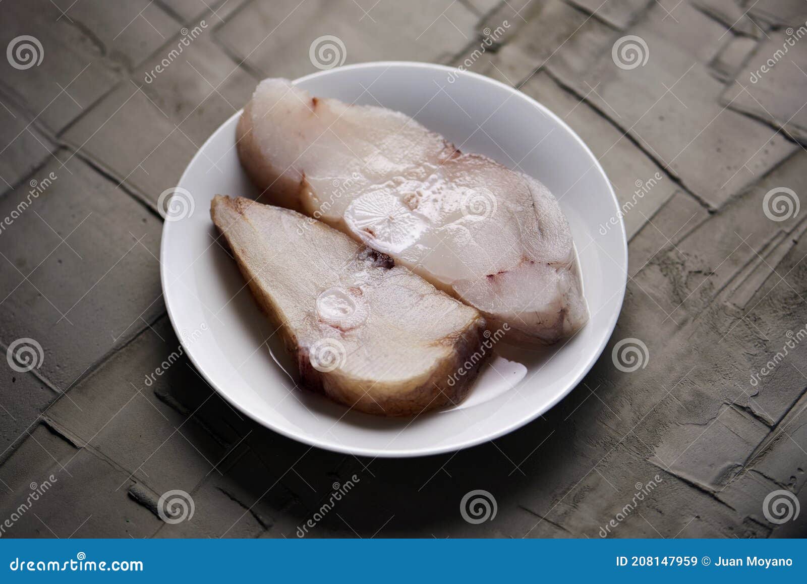 A Pair of Slices of Raw Monkfish in a White Plate Stock Image - Image ...