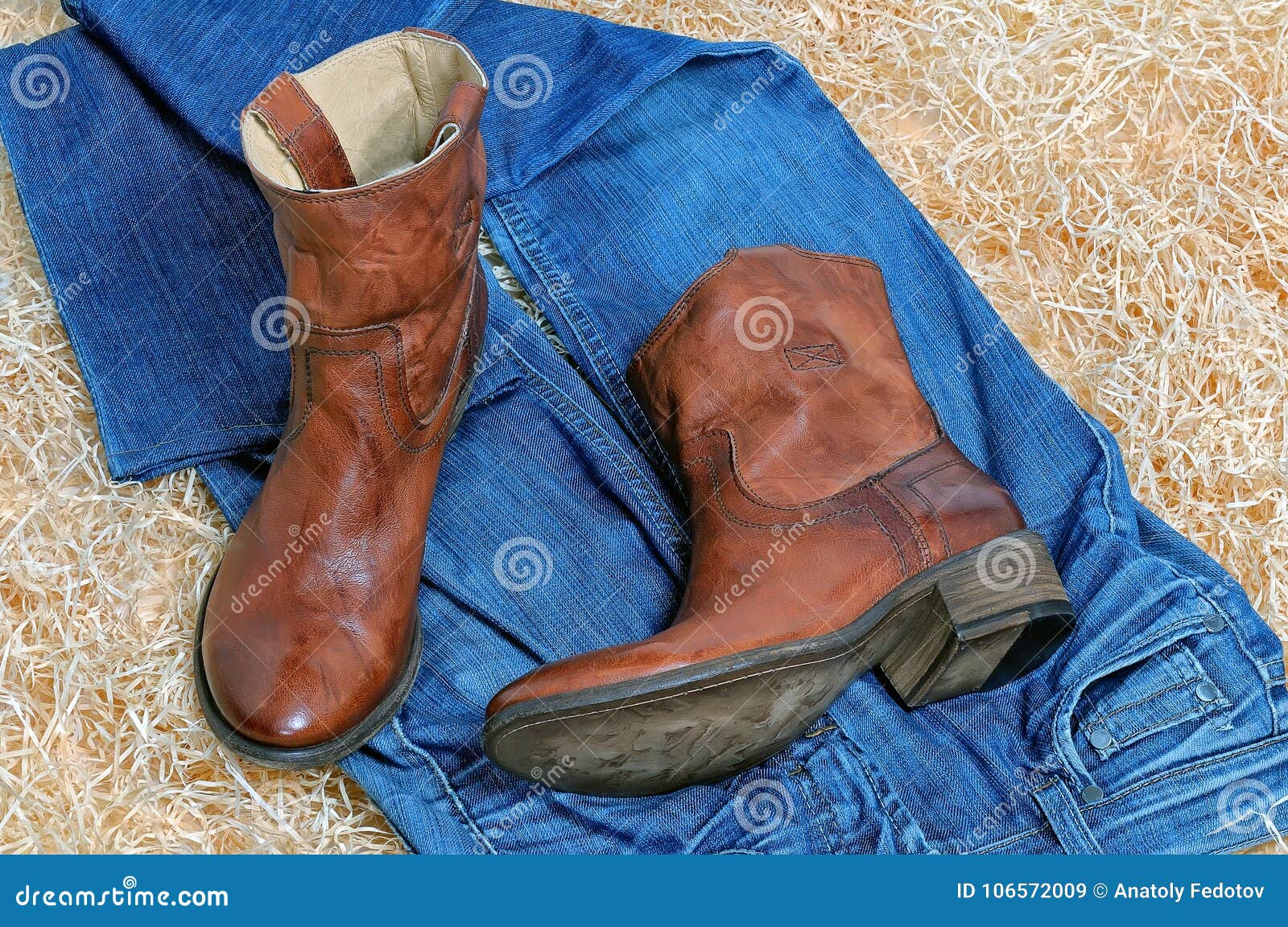 Pair of Cowboy Boots and Blue Jeans on Straw Stock Image - Image of ...