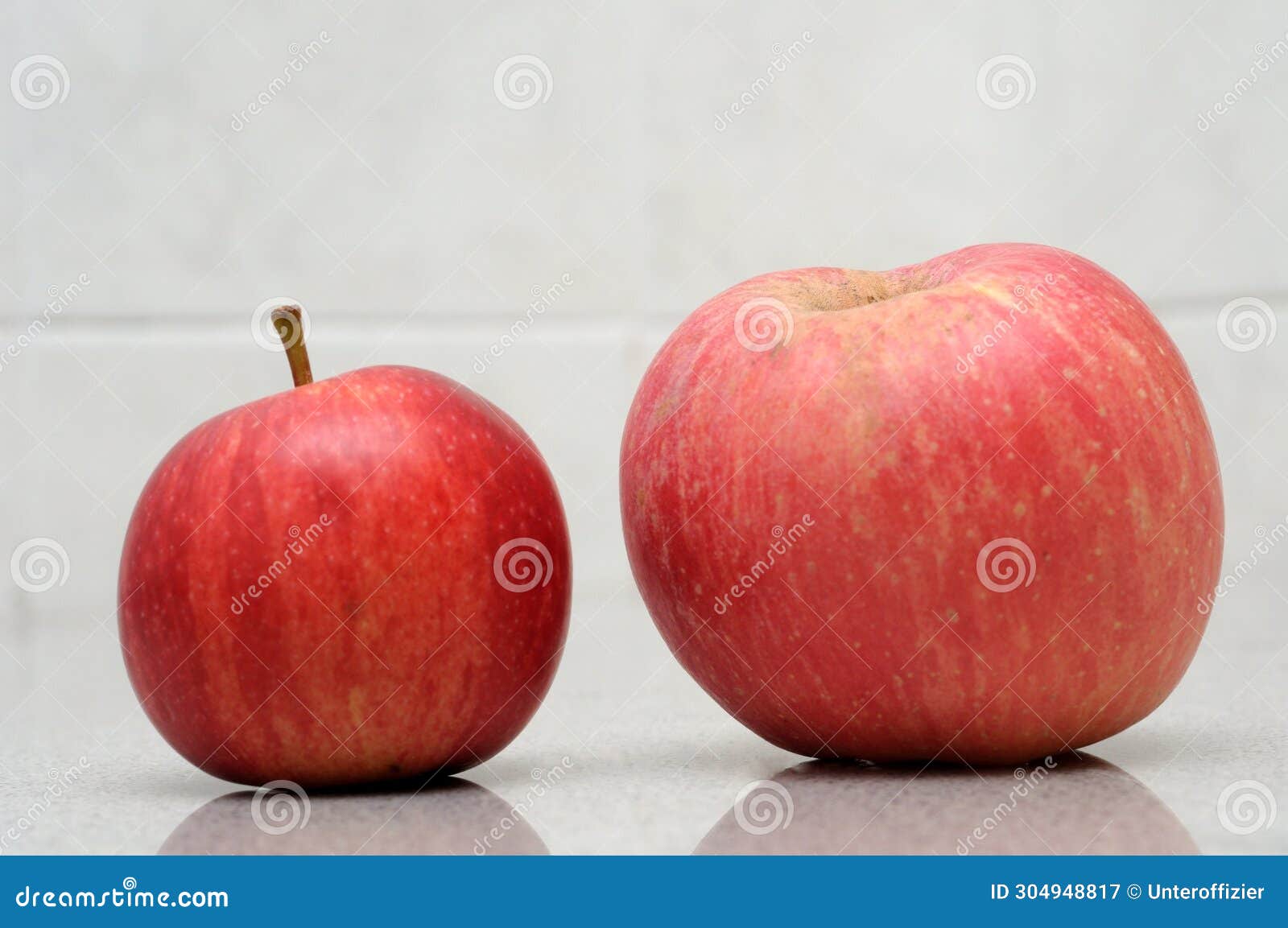 A Pair of Two Apples of Different Sizes Side by Side in Comparison ...