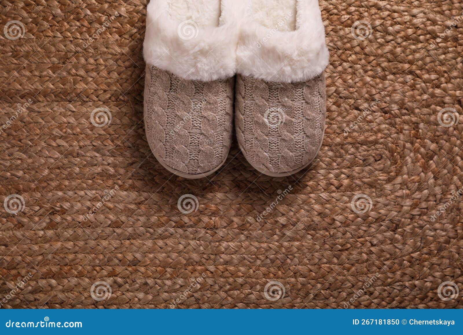 Pair of Warm Stylish Slippers on Wicker Carpet, Top View. Space for ...