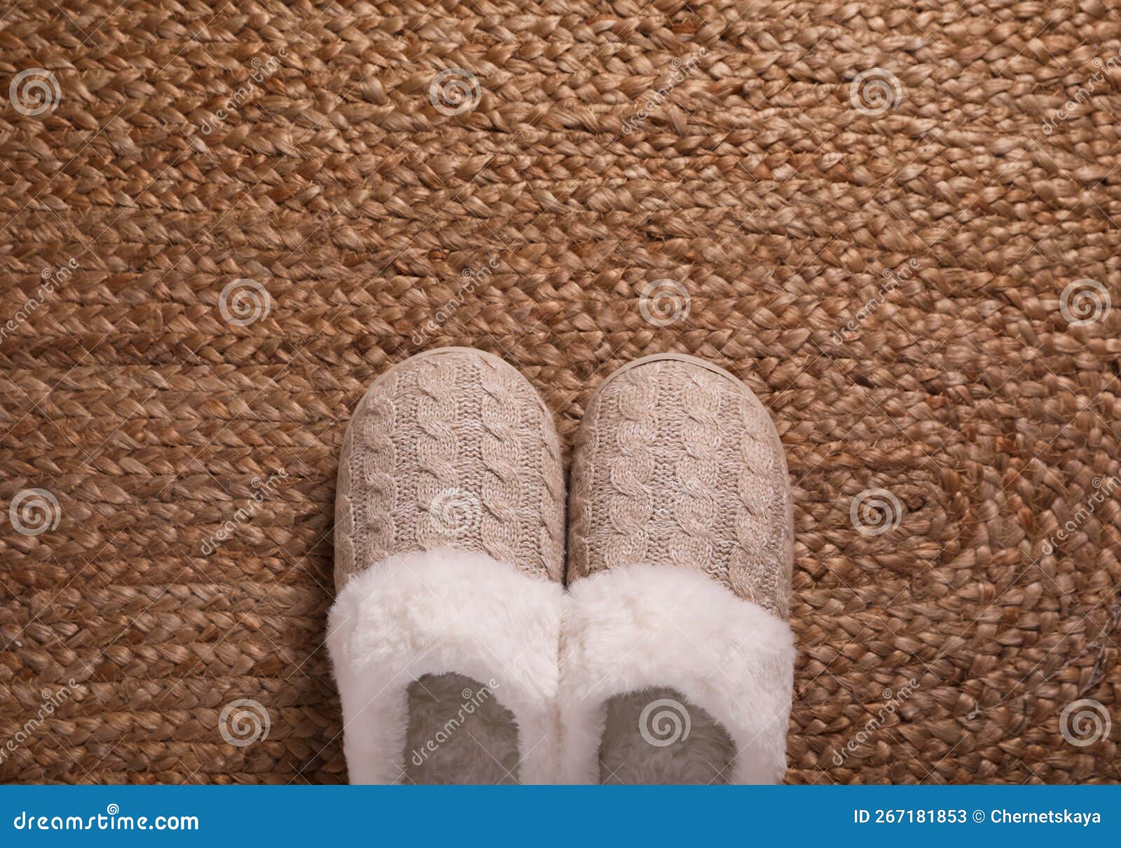 Pair of Warm Stylish Slippers on Wicker Carpet, Top View. Space for ...