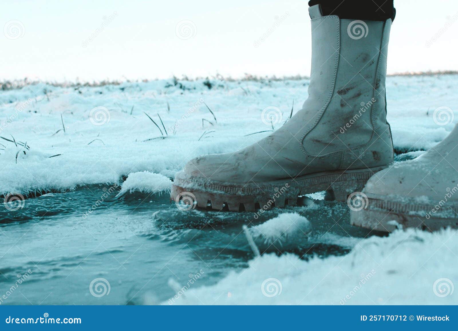Pair of White Winter Boots Standing on the Ice with Snow Around Stock ...