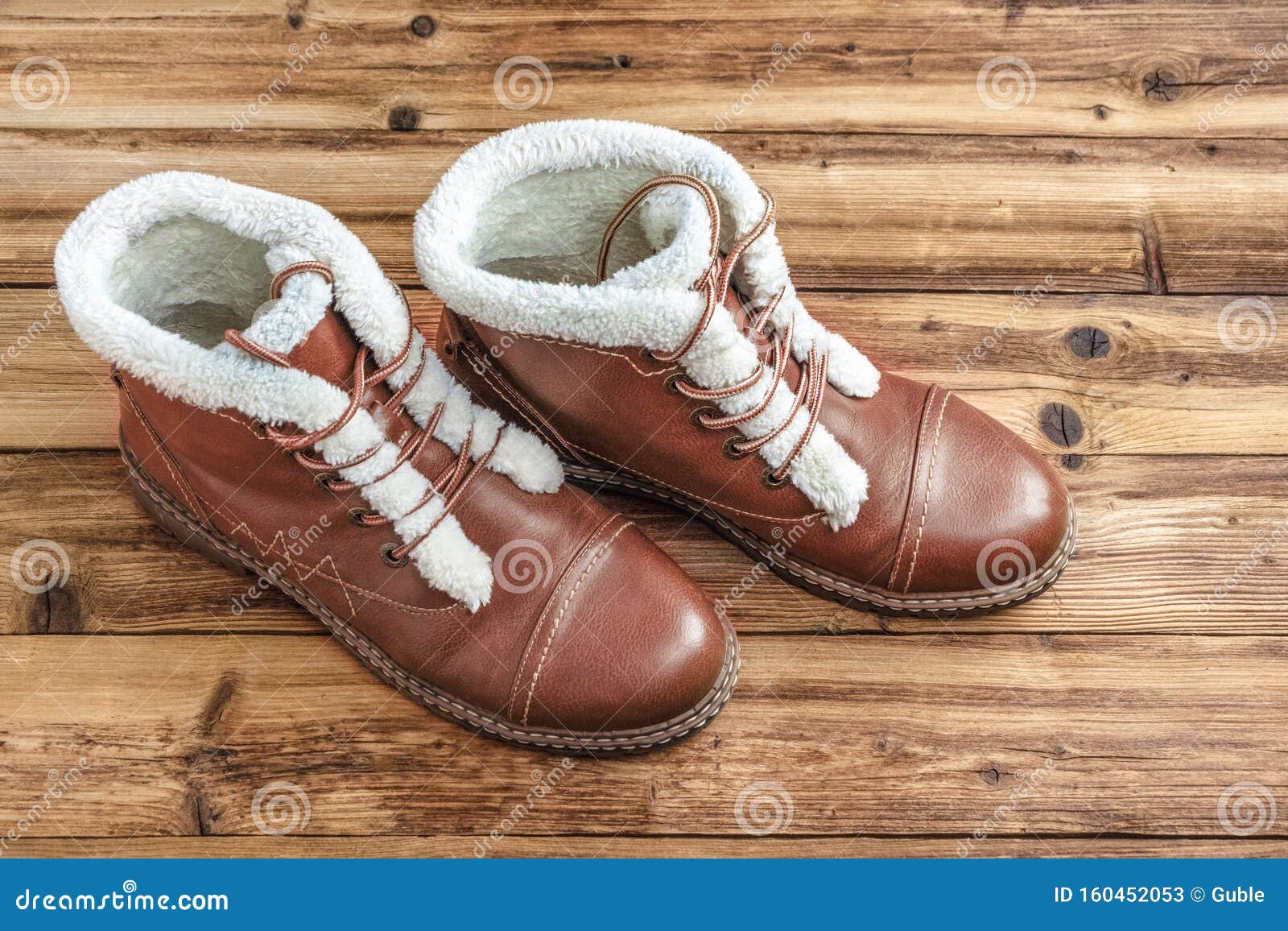 A Pair of Winter Brown Boots on a Wooden Background Stock Image - Image ...