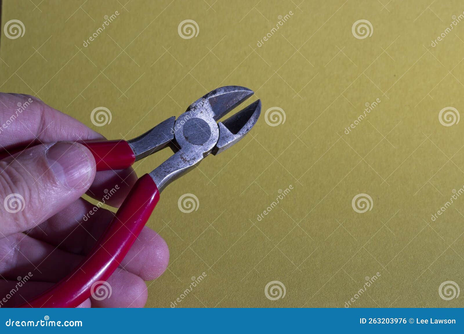 A Pair of Wire Cutters Held in Hand Stock Photo - Image of held, yellow ...