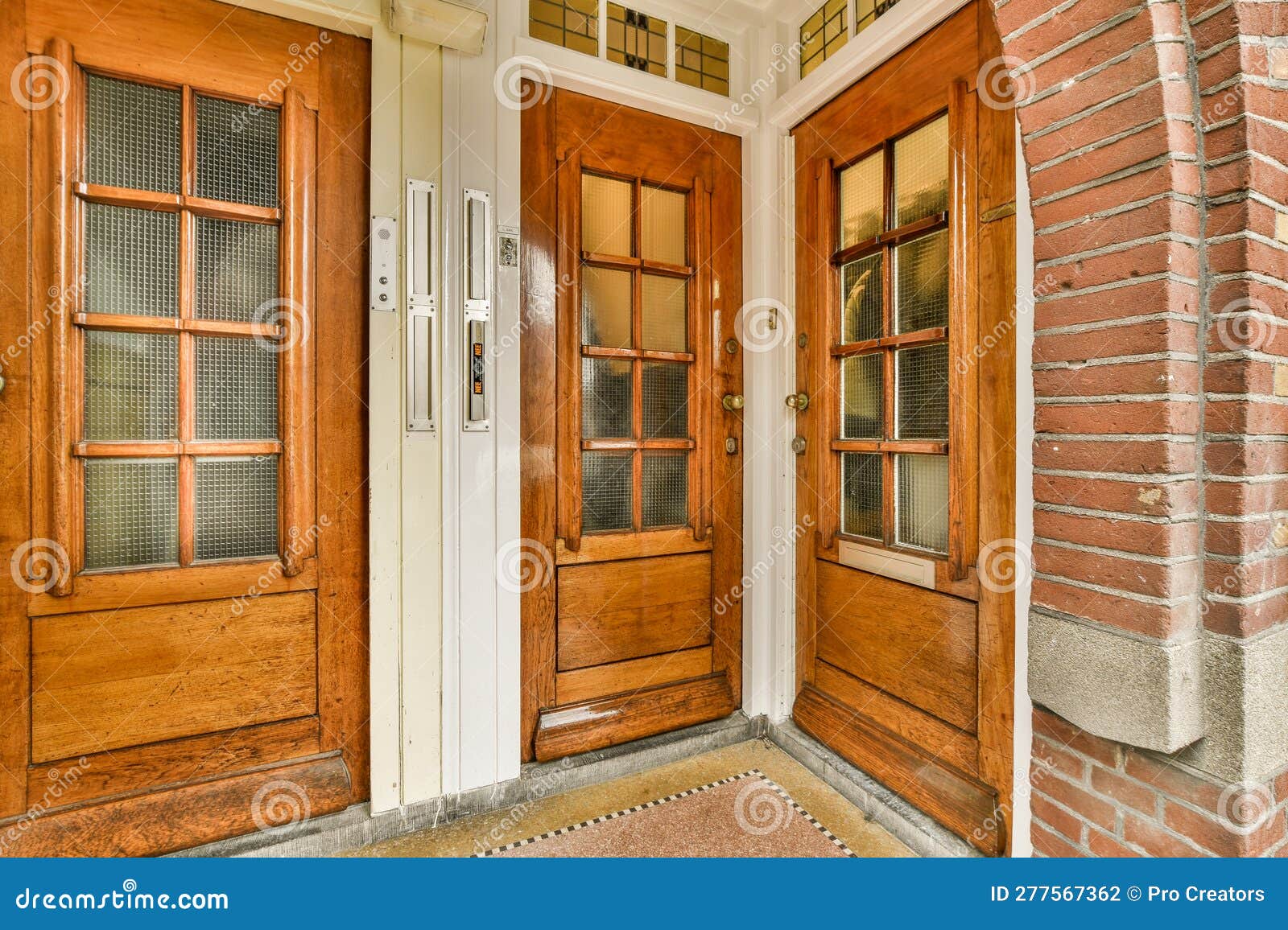 A Pair of Wooden Doors on a Brick Building Stock Photo - Image of ...