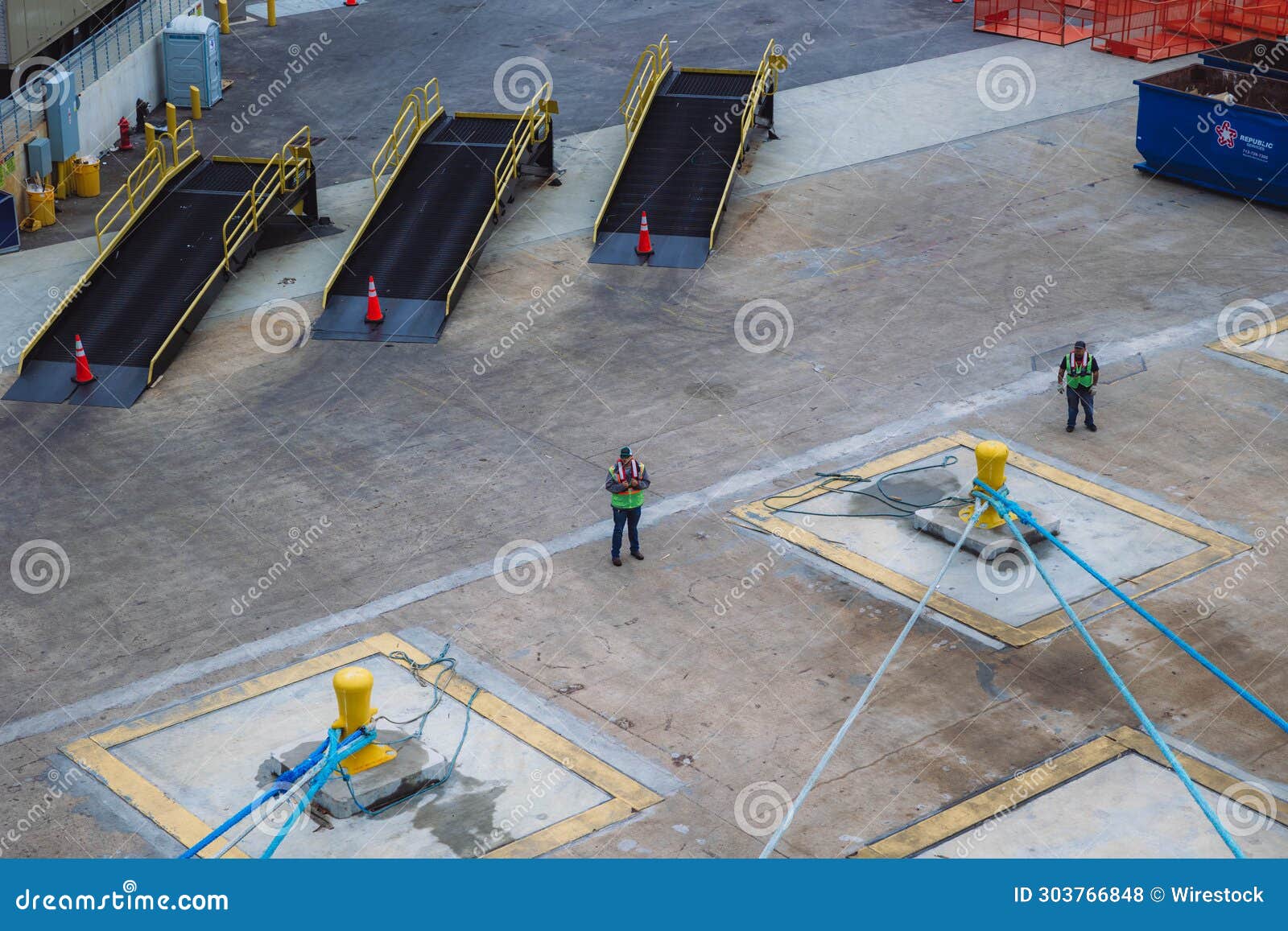 Pair of Workers are Hard at Work Preparing Ramps for a Cruise Ship in a ...