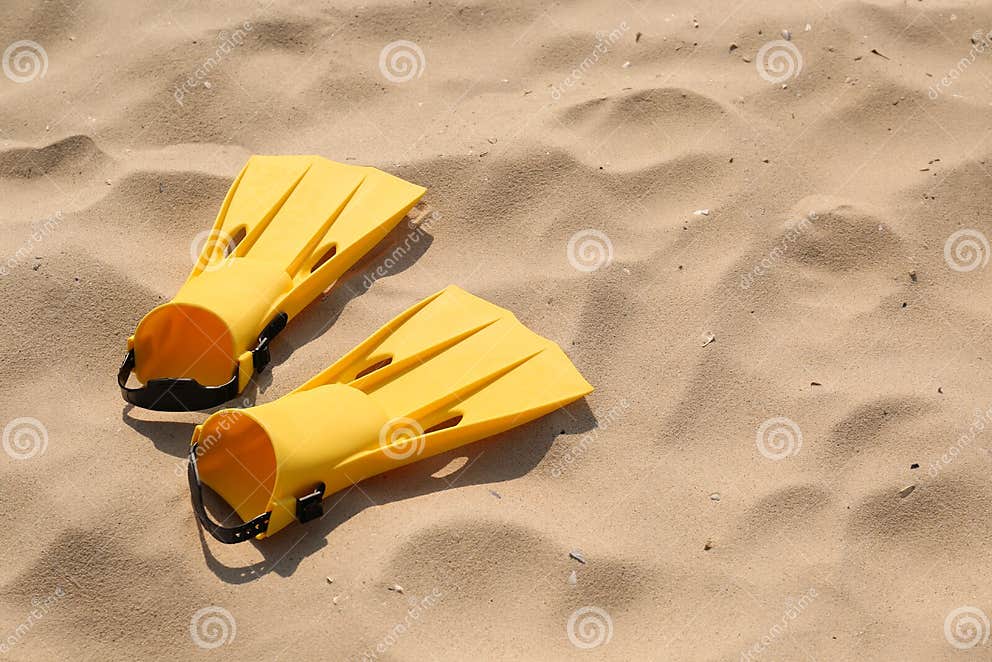Pair of Yellow Flippers on Sand. Space for Text Stock Photo - Image of ...