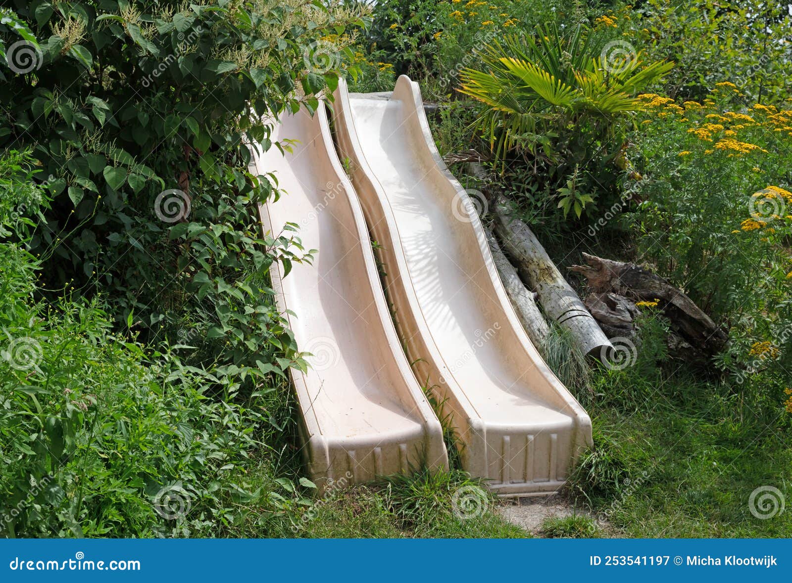 Pair of Slides on a Green Slope Stock Image - Image of child ...