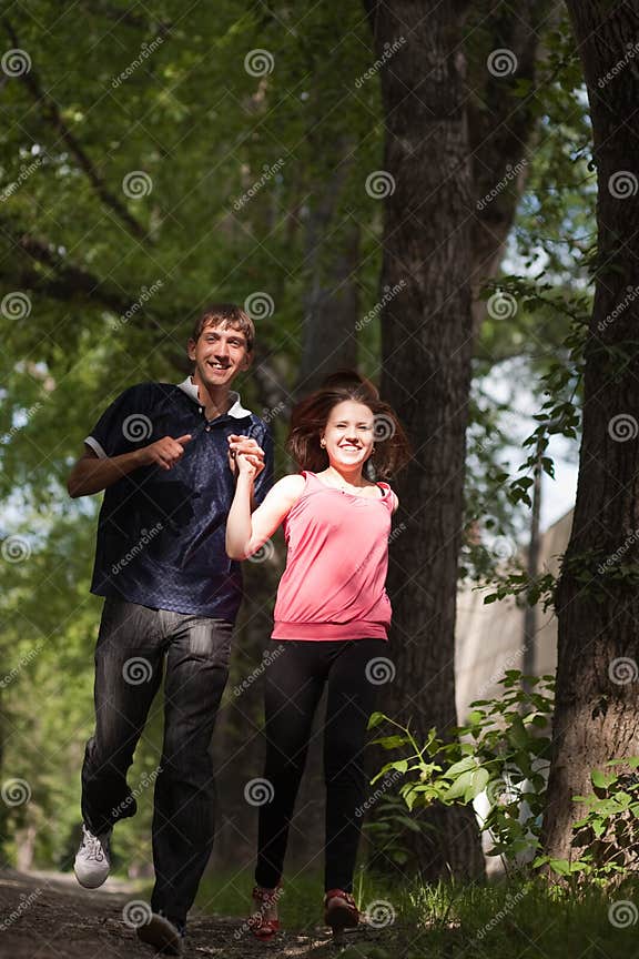 Pair of Young Lovers Running in the Park Stock Image - Image of ...