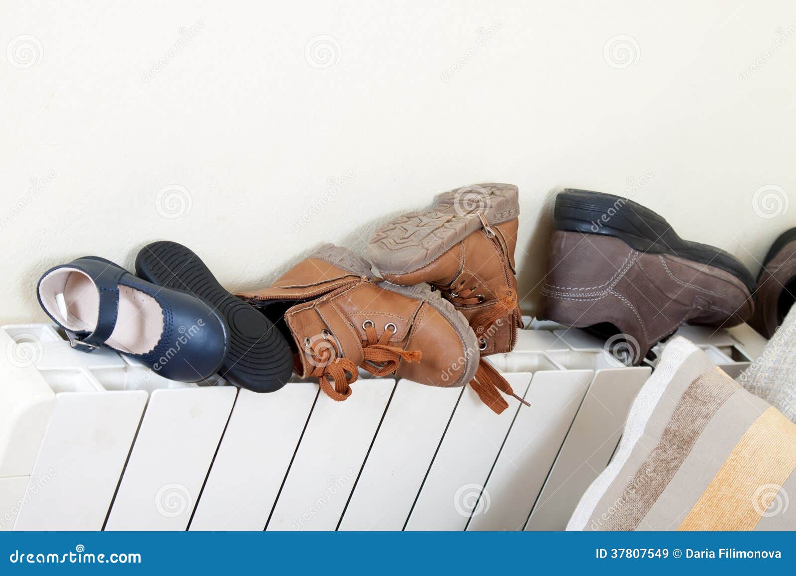 Pairs of shoes on radiator stock image. Image of fashion - 37807549