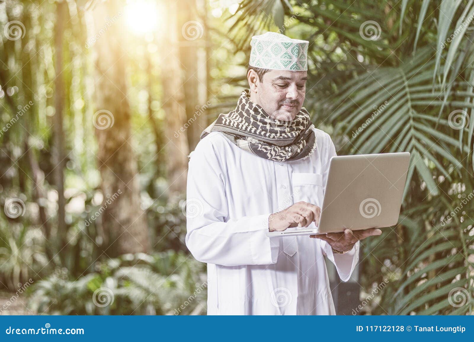 Pakistani Muslim Man Standing and Working on Notebook Stock Photo ...