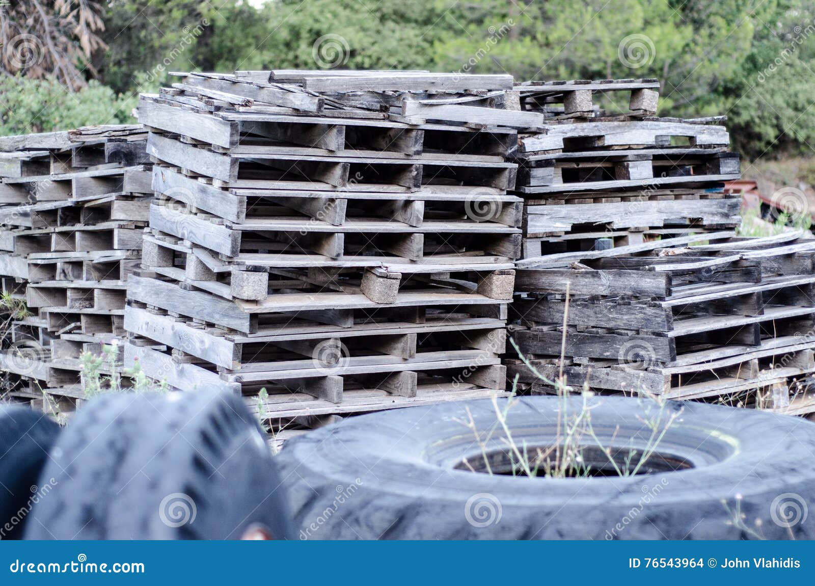 Pallets of wood and tires stock photo. Image of object - 76543964