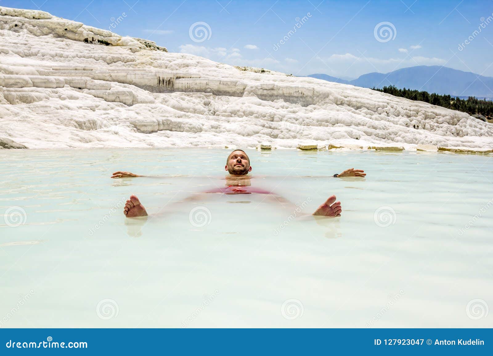 A Man Swims In The Pool Of Thermal Springs And Travertine Pamukkale ... A Man Swims In The Pool Of Thermal Springs And Travertine Pamukkale ...