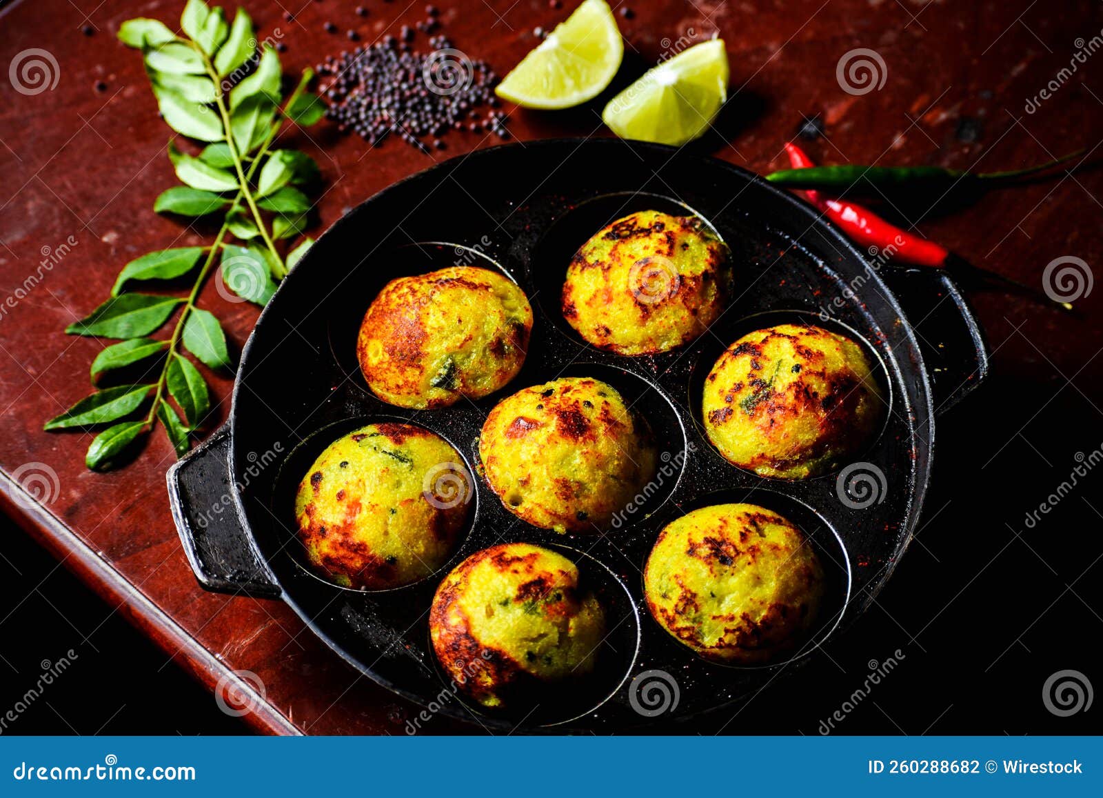 Pan with Fried Dish in Designated Small Areas on a Red Marble Table ...