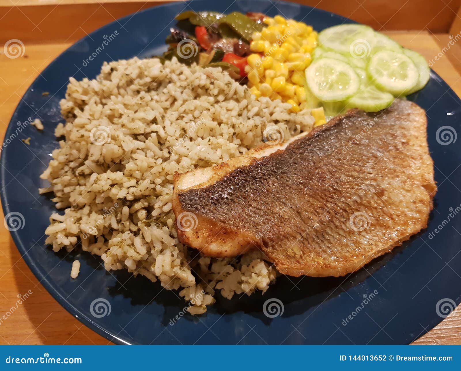 Pan Fried Dorado with Spinach Rice and Vegetables Stock Photo - Image ...