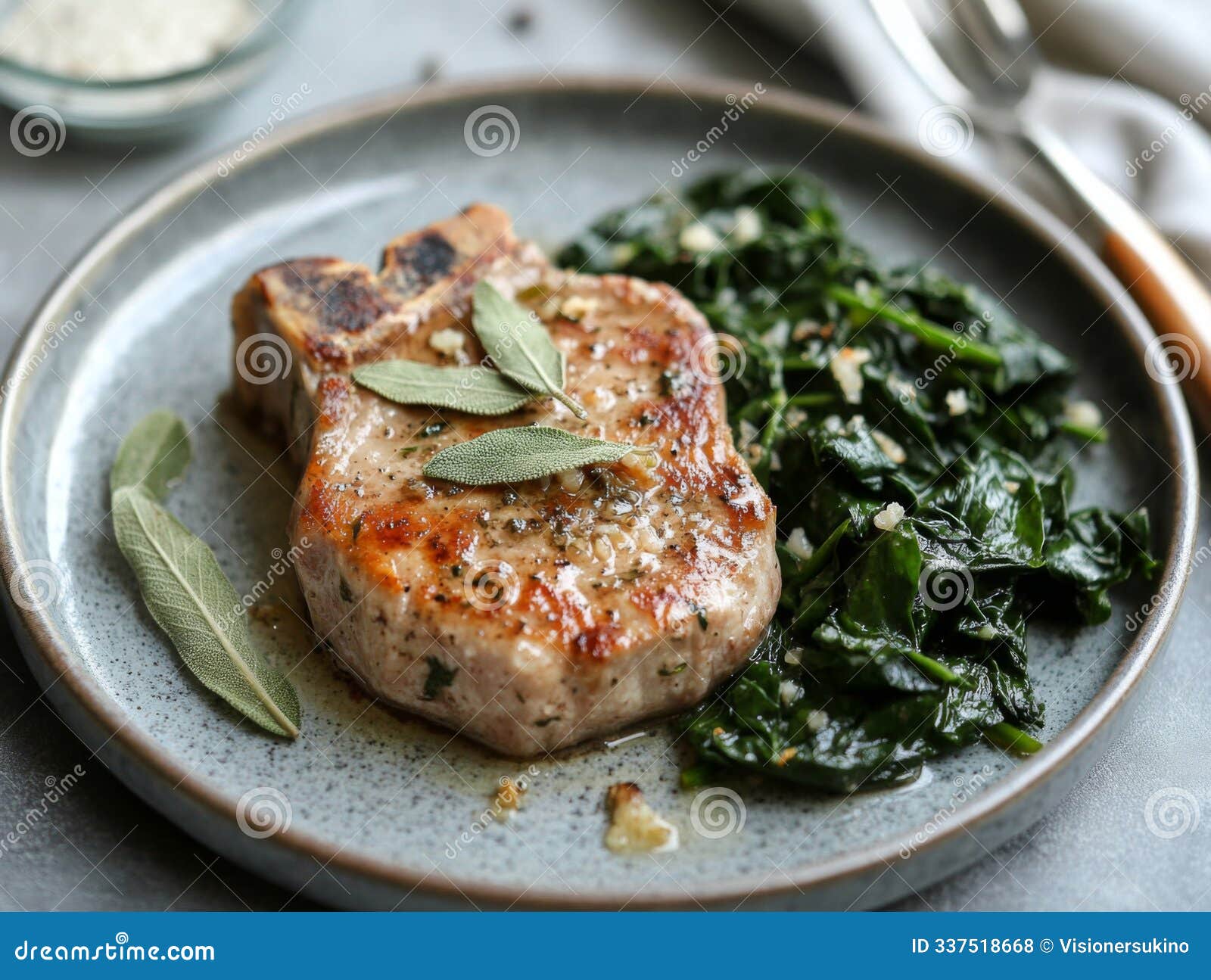 Pan-Seared Pork Chops With Sauteed Spinach And Parsley Royalty-Free ...