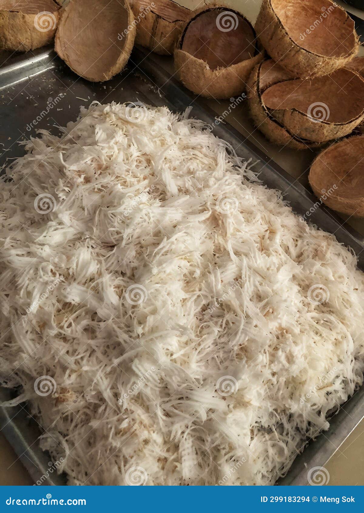 A Pan of Shredded Coconut Sitting on Top of a Counter. White Coconuts ...