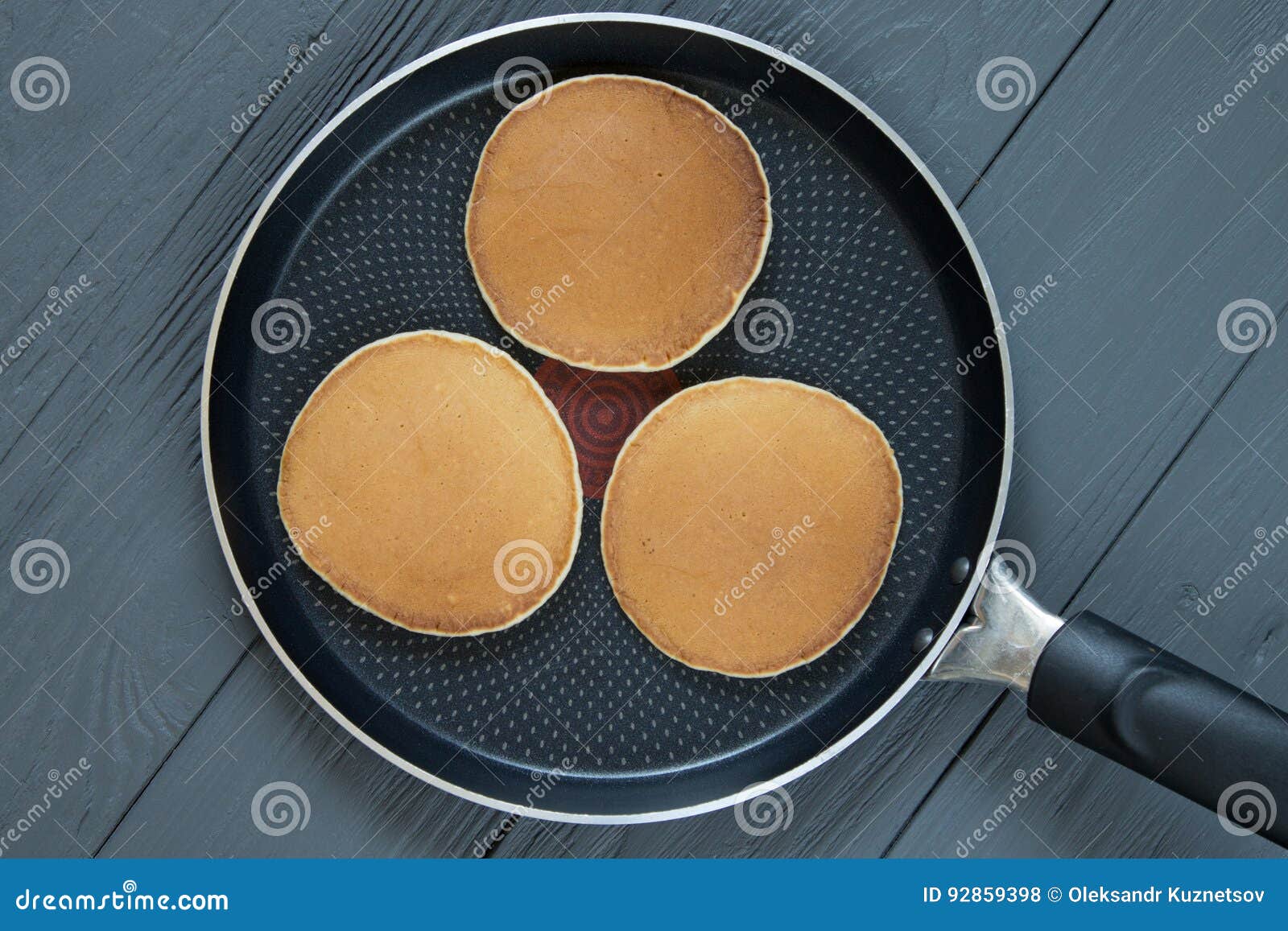 Pancakes in a Frying Pan on Wooden Surface Stock Photo - Image of food ...