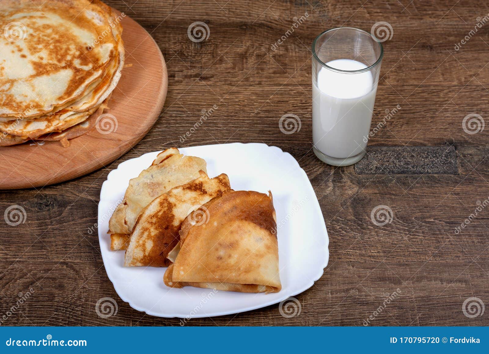 Pancakes in a Plate and a Glass of Milk are on a Dark Table. Stock ...