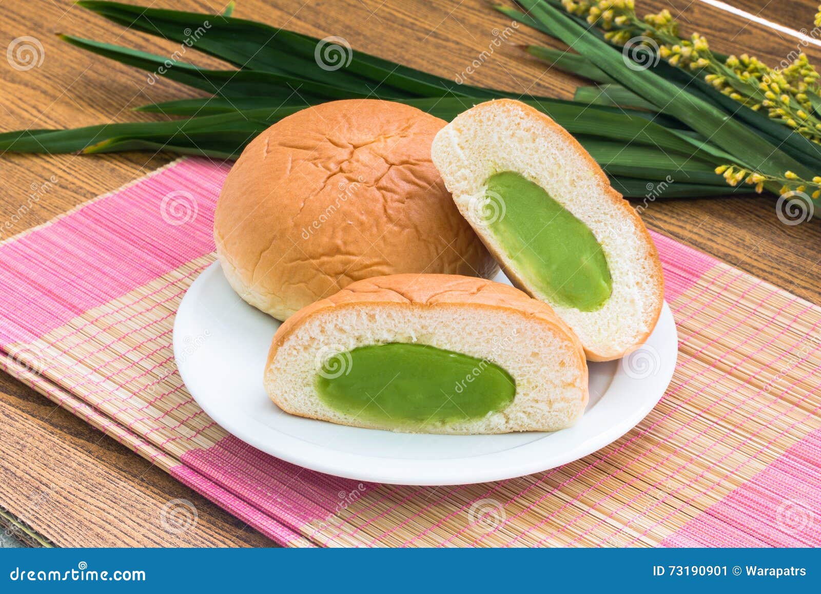 Pandan Custard Bun on Bamboo Mat with Pandan Leaf Still Life St Stock ...