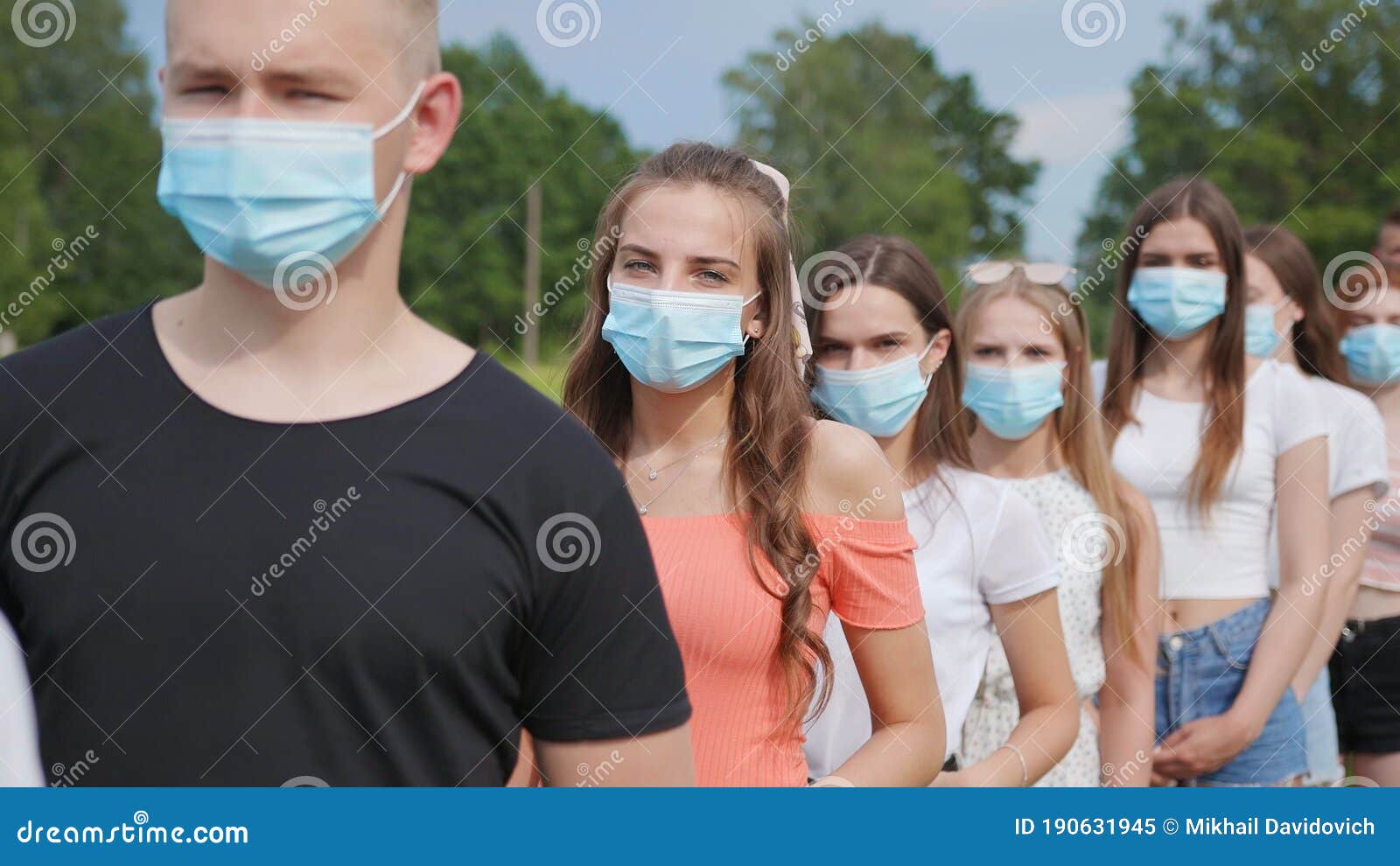 Pandemic Concept. a Group of Students Stand in a Row in Masks. Stock ...