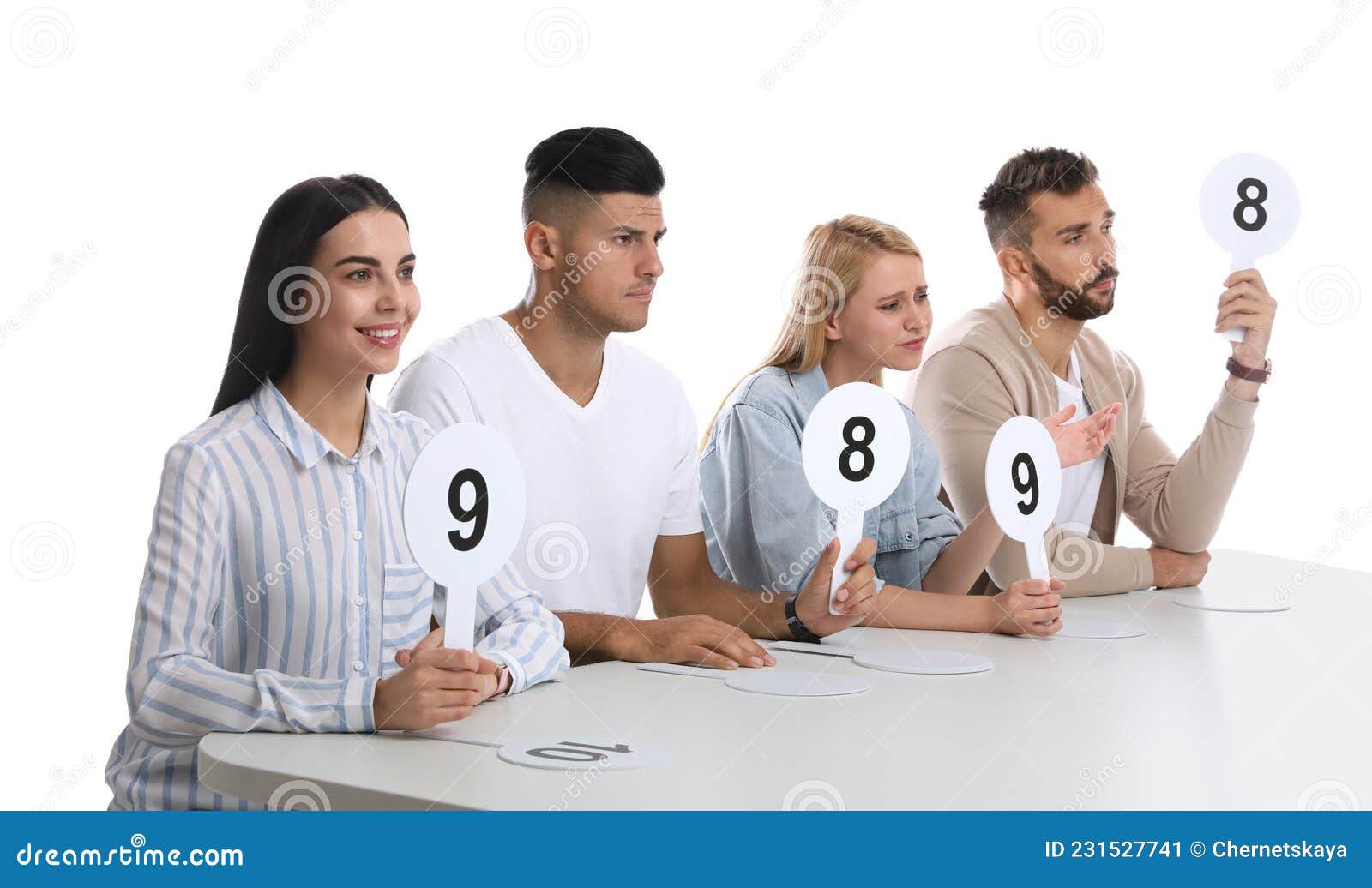 Panel of Judges Holding Different Score Signs at Table on White ...