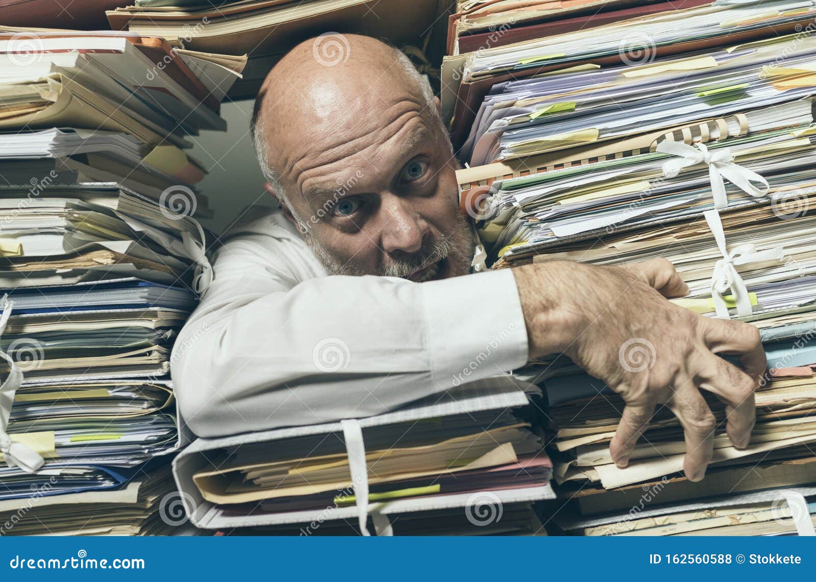Panicked Businessman Overloaded with Paperwork Stock Photo - Image of ...