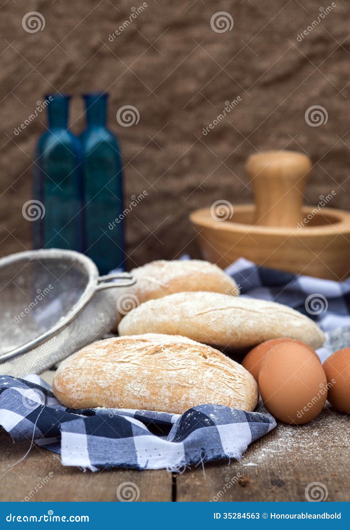Panini Rolls in Rustic Kitchen Setting with Cooking Utensils Stock ...
