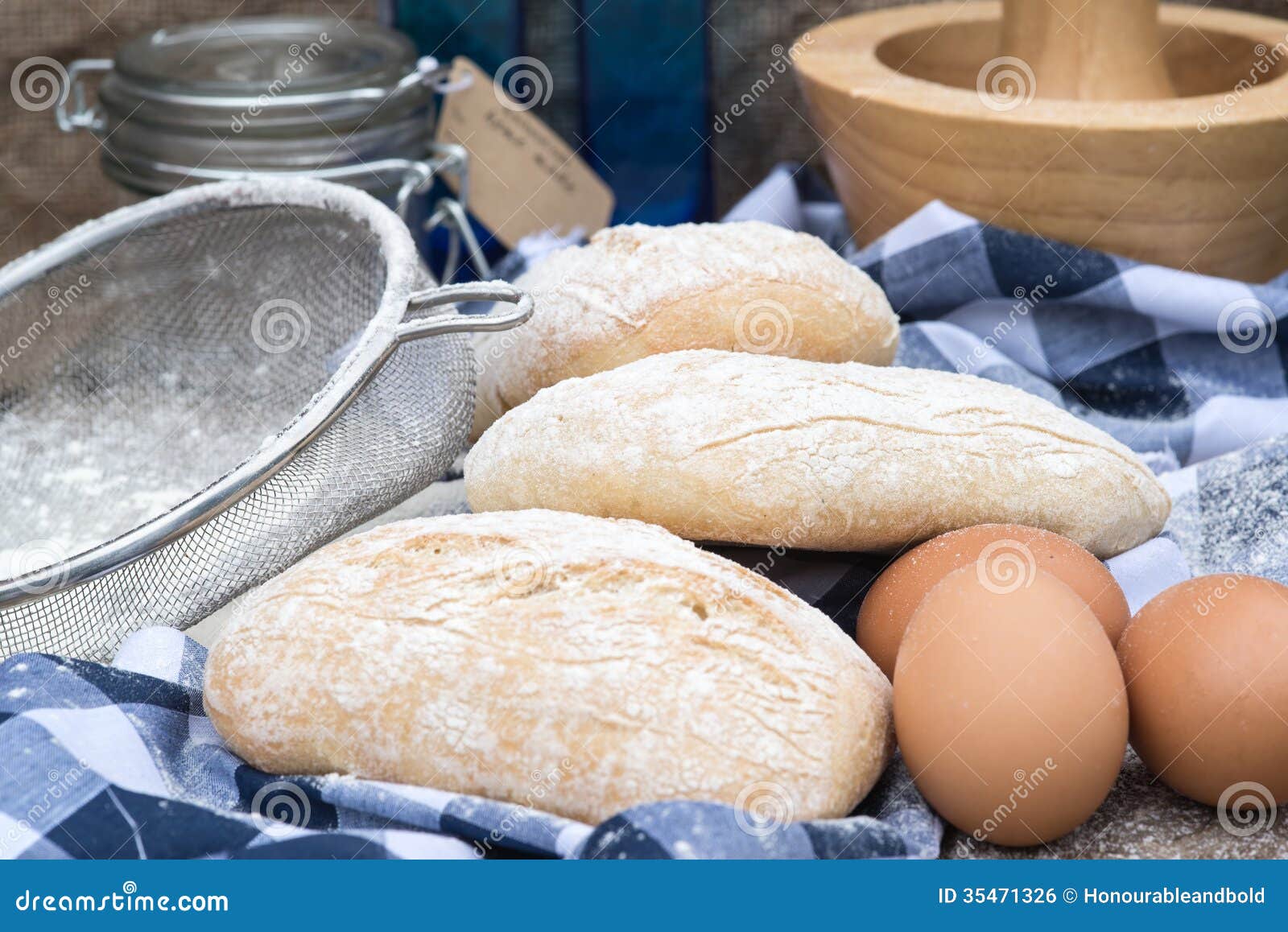 Panini Rolls in Rustic Kitchen Setting with Cooking Utensils Stock ...