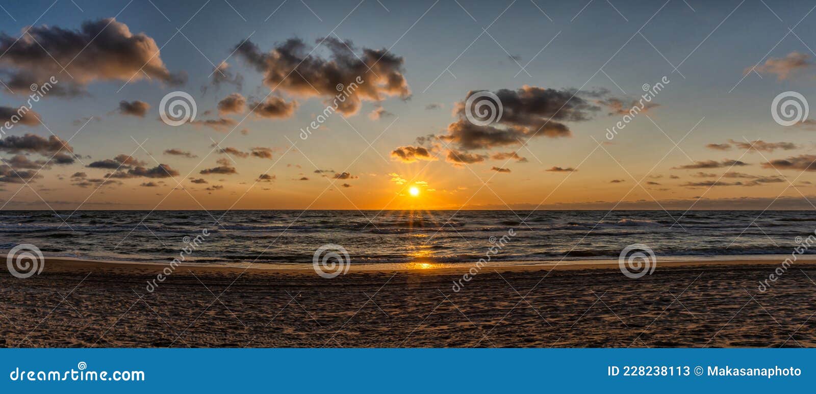 Panorama of a Colorful Beach Sunset with the Sun Dropping into the ...