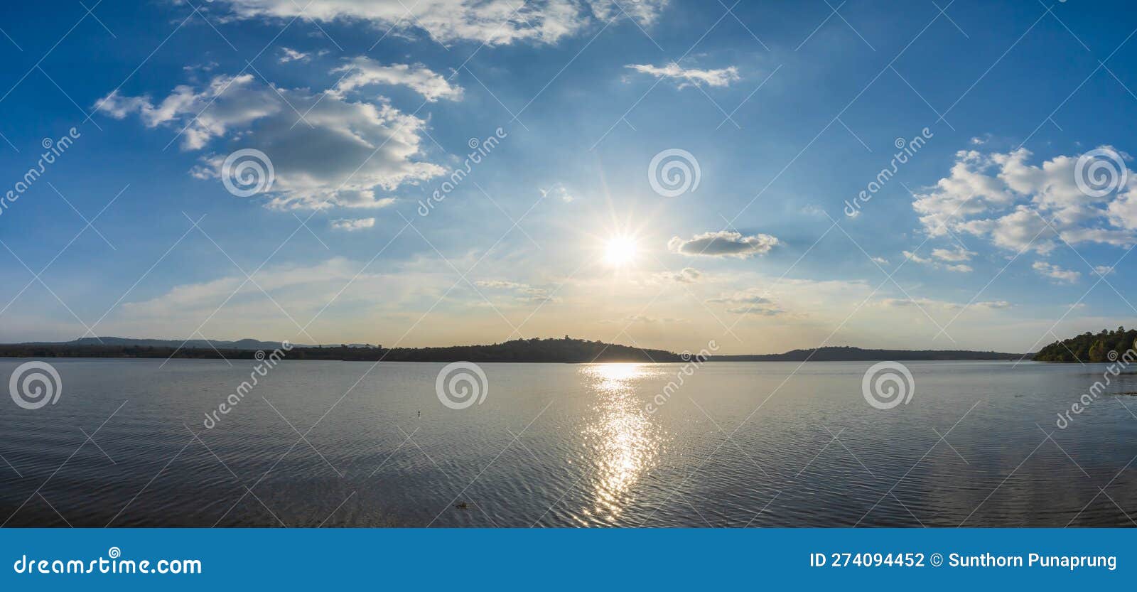 Blue Sky and Wispy White Clouds and Sun Over the River Stock Photo ...