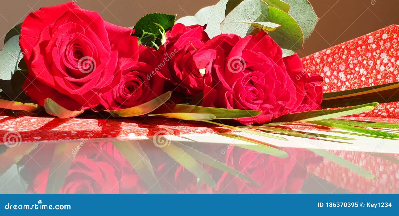 Red Roses with Reflection on the Table in Sunlight. Stock Image - Image ...
