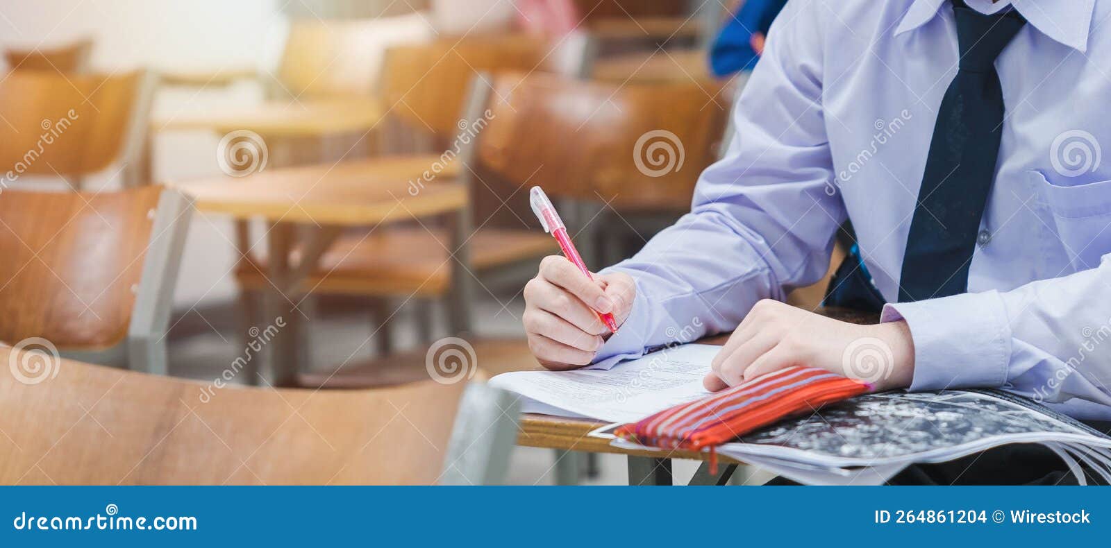 Panoramic Shot of a College Student Writing on Final Examination Papers ...