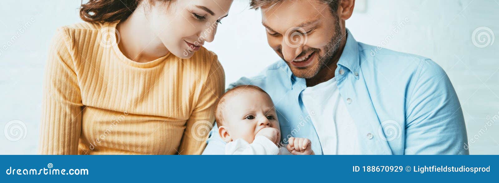 Shot of Happy Parents Smiling while Looking at Cute Infant Stock Image ...