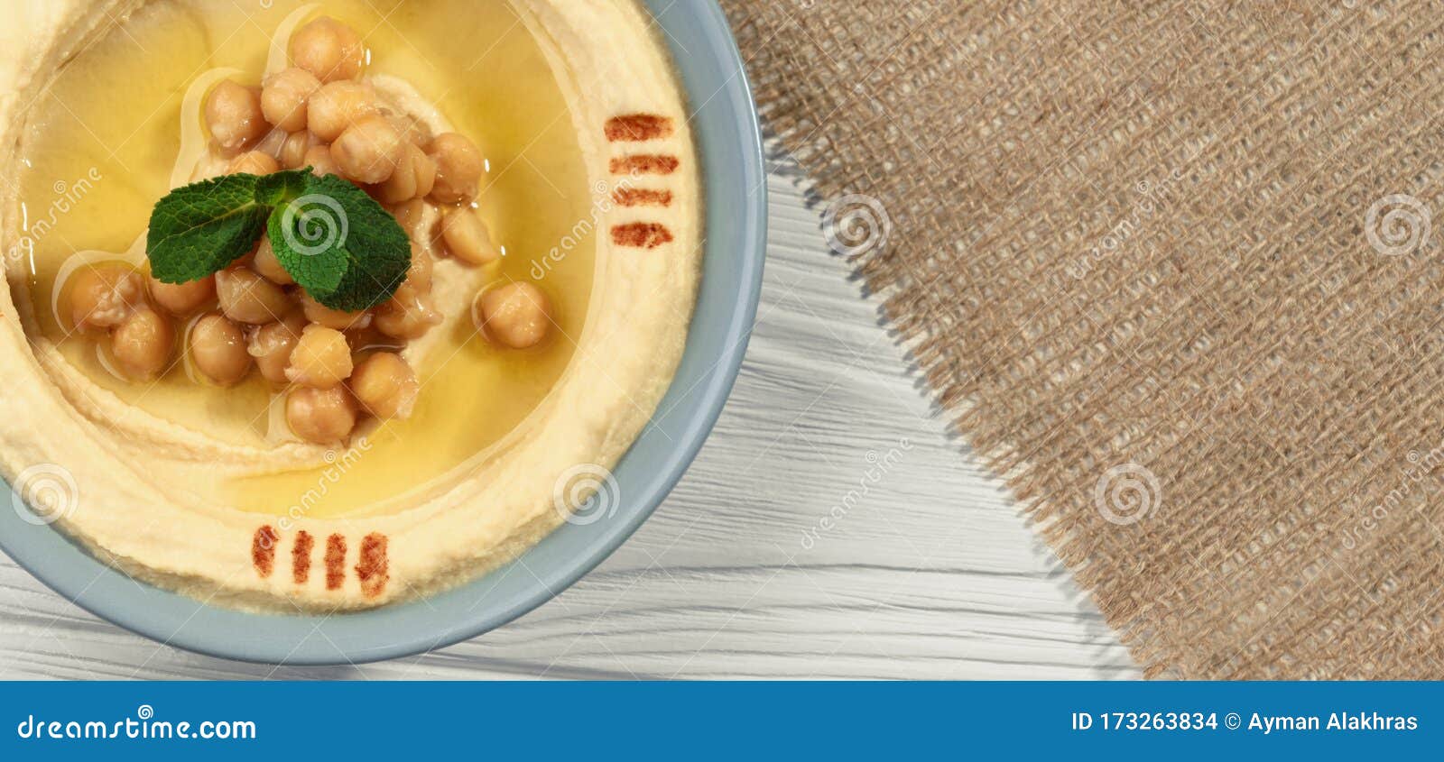 Panoramic Shot of Hummus Dish on Hessian Sack and Wooden Surface Stock ...