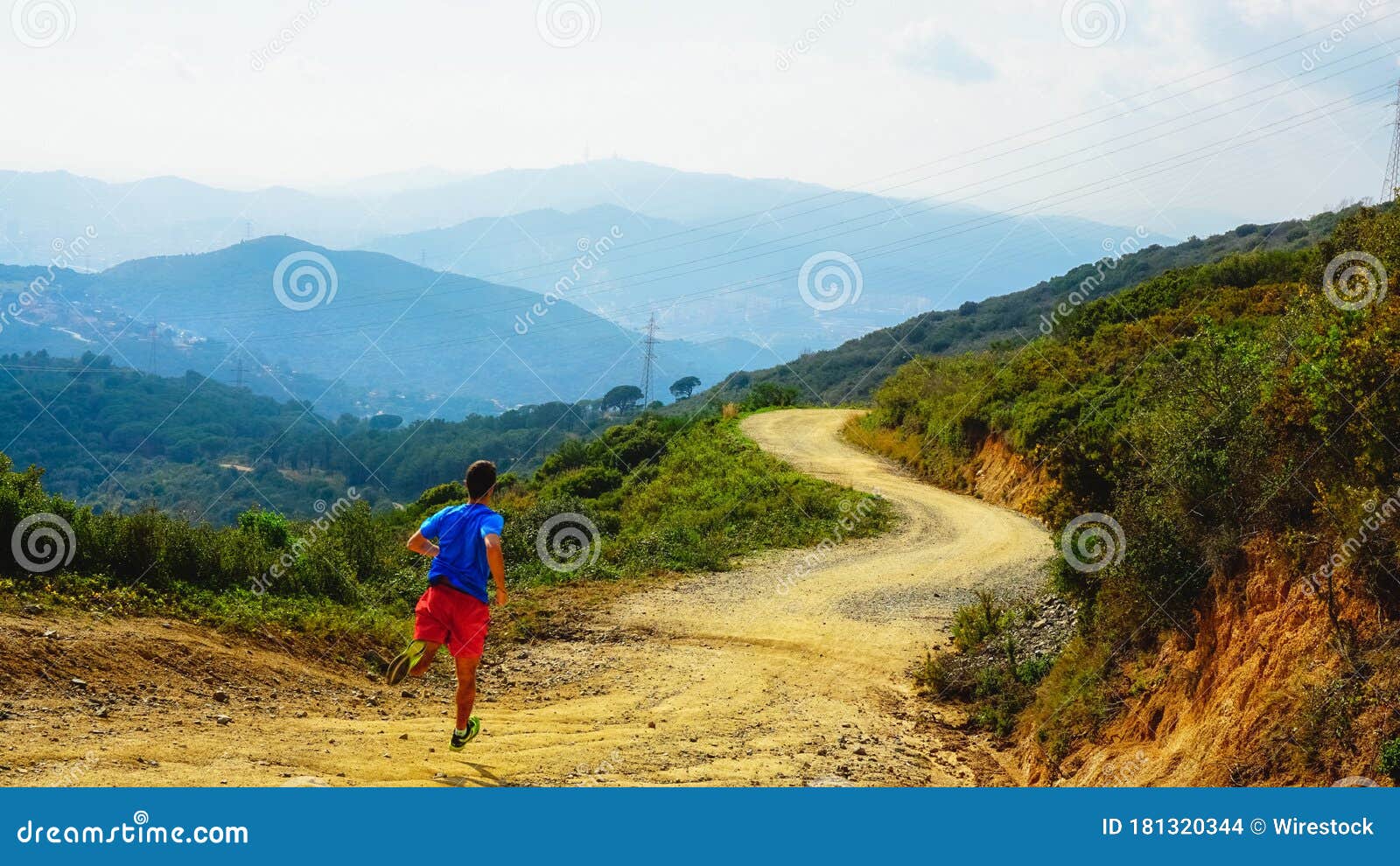 Panoramic Shot of a Man Running on a Pathway Surrounded by Trees and ...